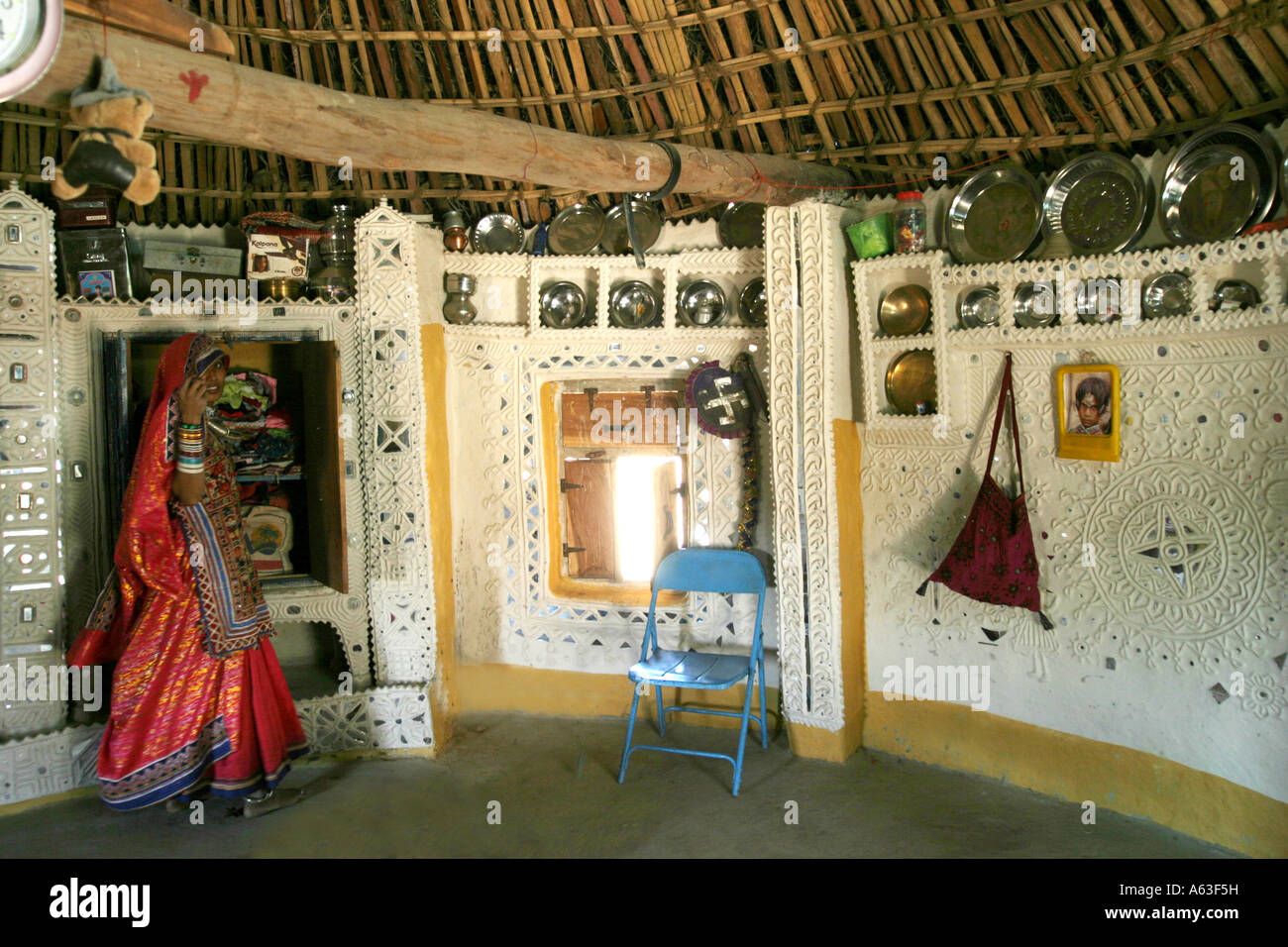 Banni tribal woman in her decorated bhungas (tribal house) near Bhuj in ...
