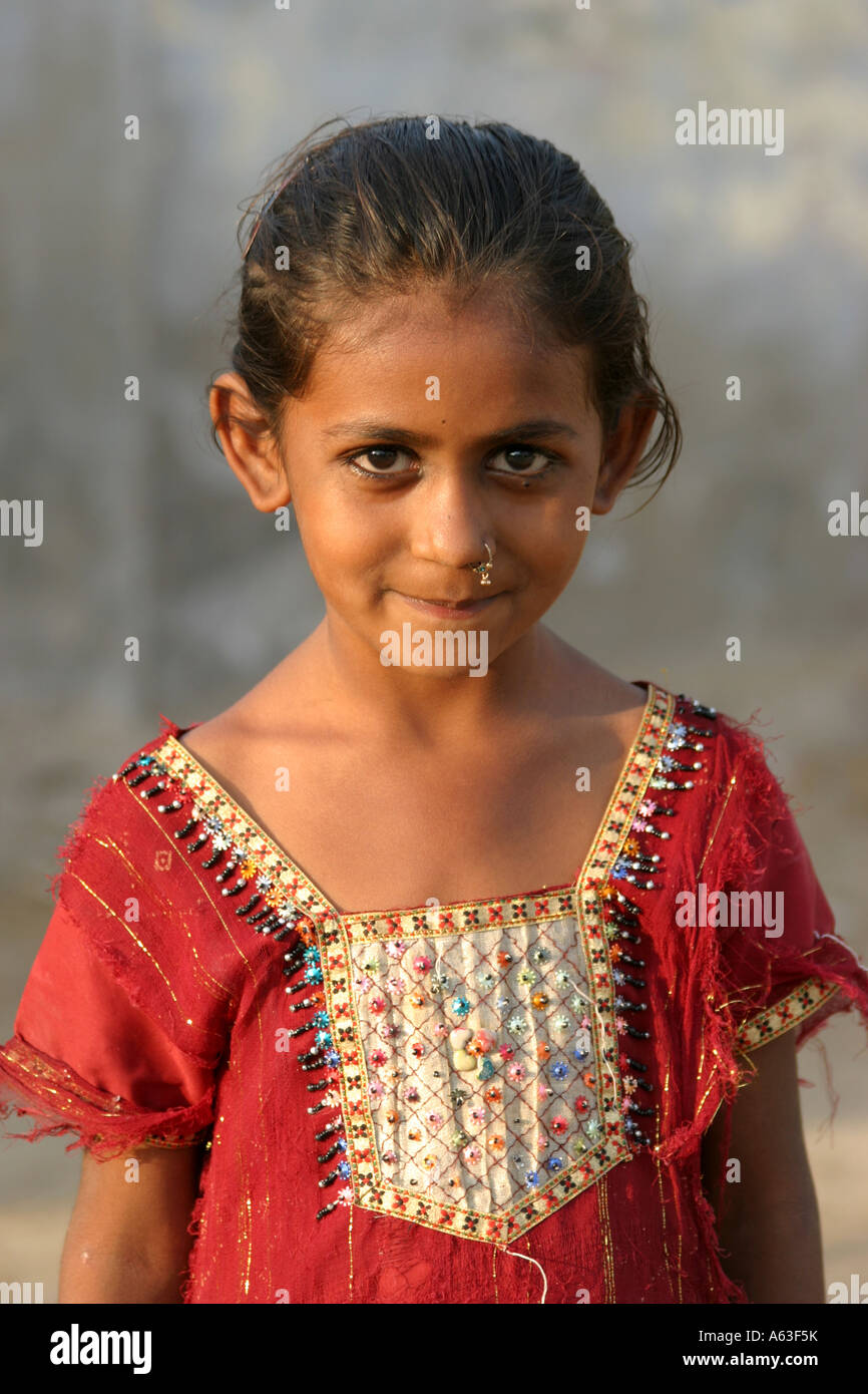 Nomadic MIR tribal little girl with enchanting smile in the Dasada area ...