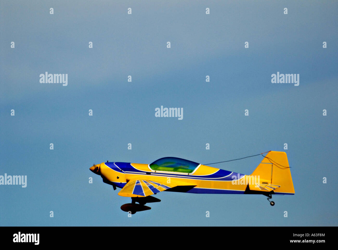 Model Airplane flying in a blue sky background Stock Photo - Alamy