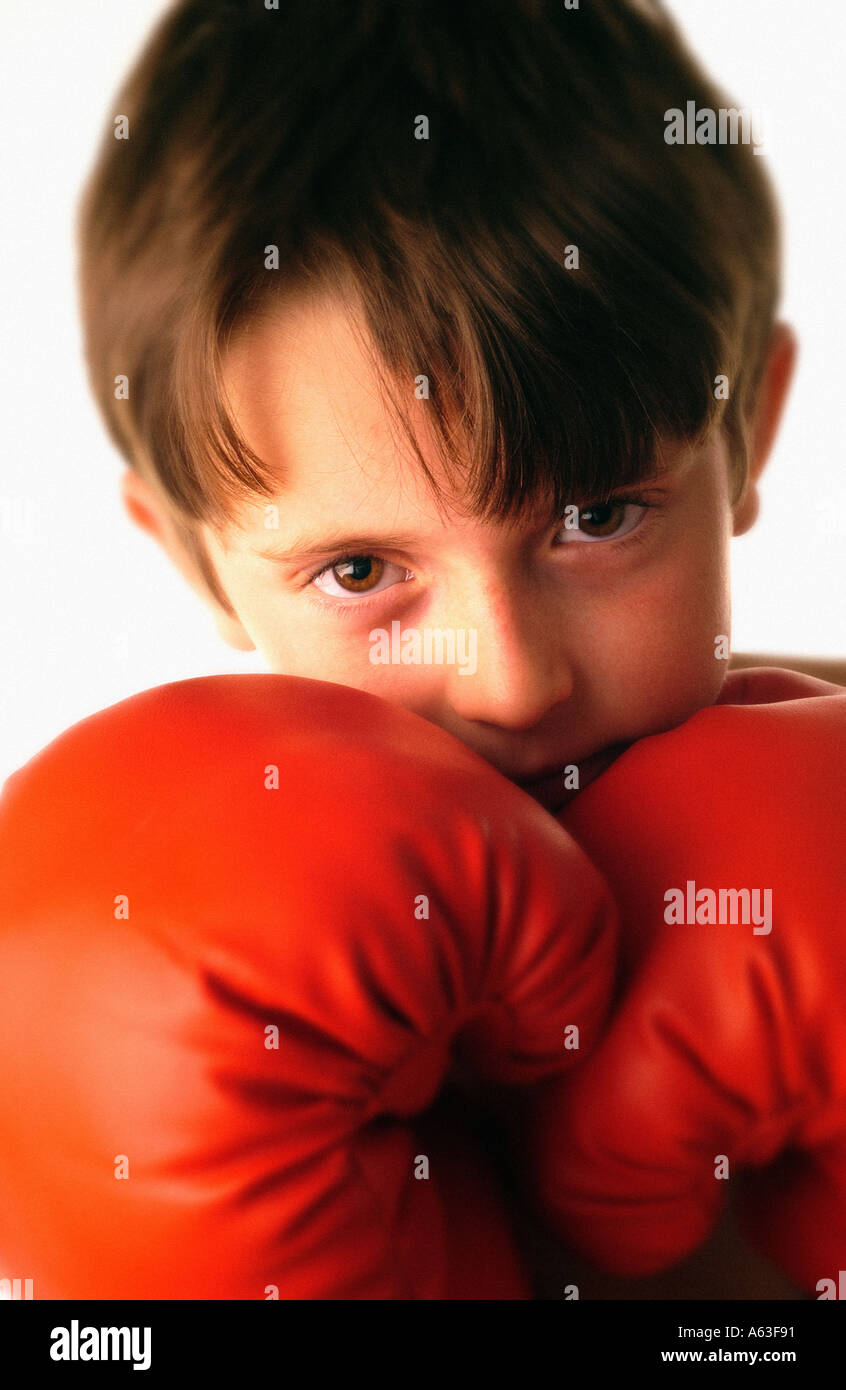 Boy hiding behind boxing gloves Stock Photo - Alamy