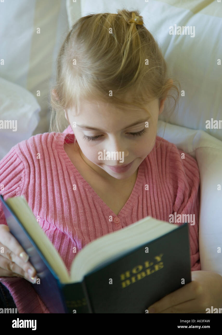Young girl reading the bible Stock Photo - Alamy