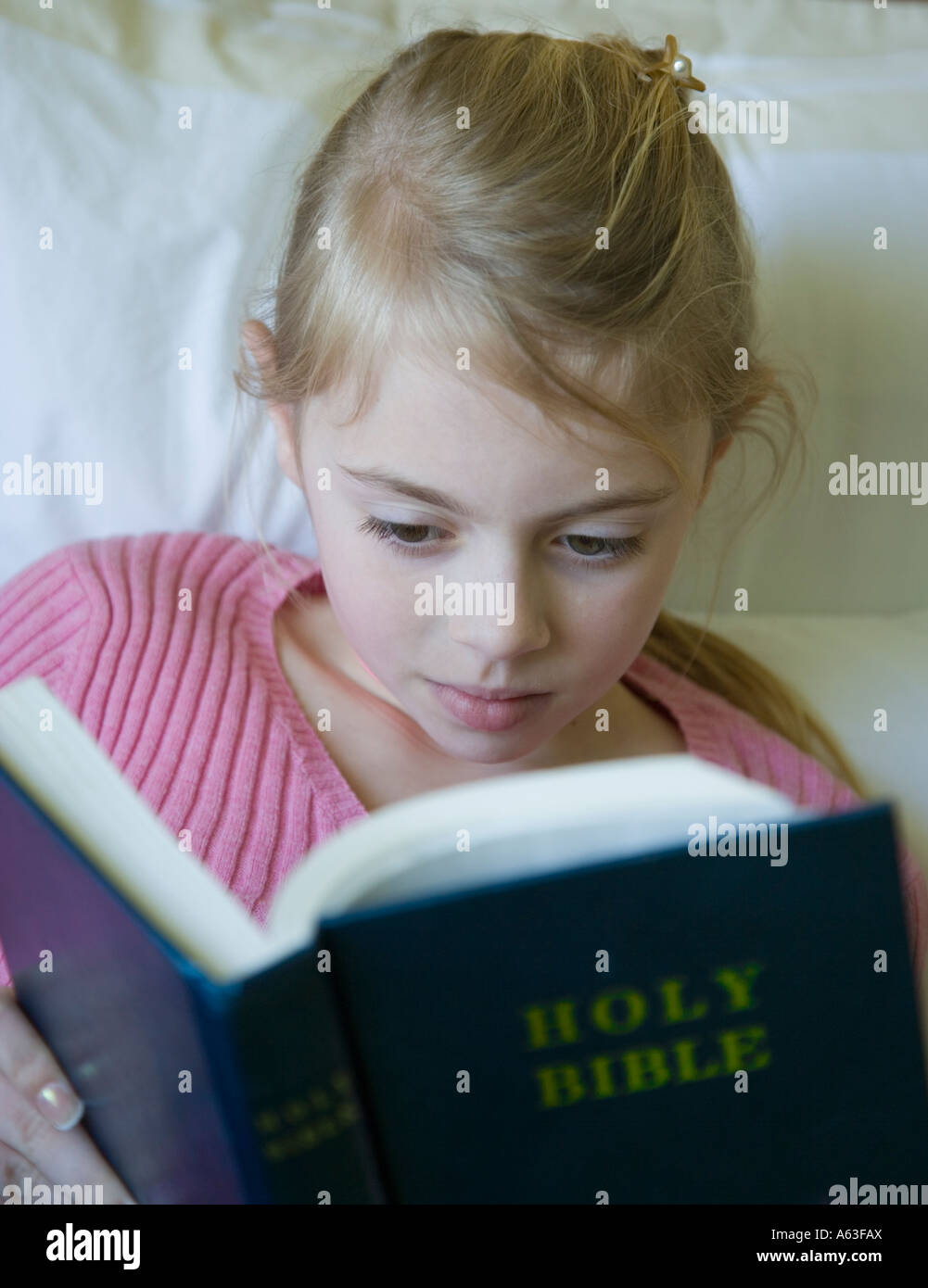 Child reading a bible Stock Photo - Alamy