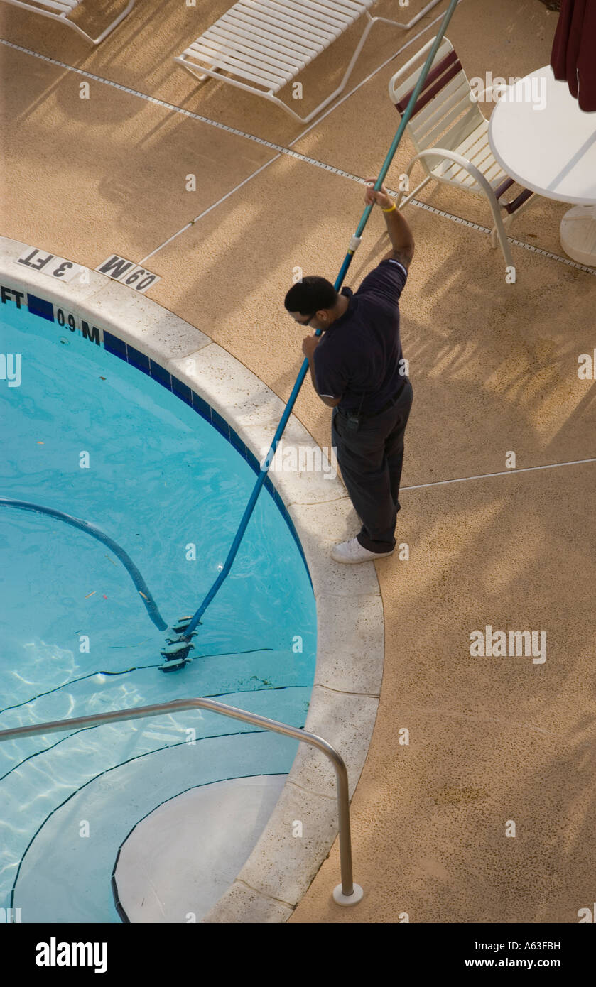 Worker cleaning a swimming pool Stock Photo - Alamy