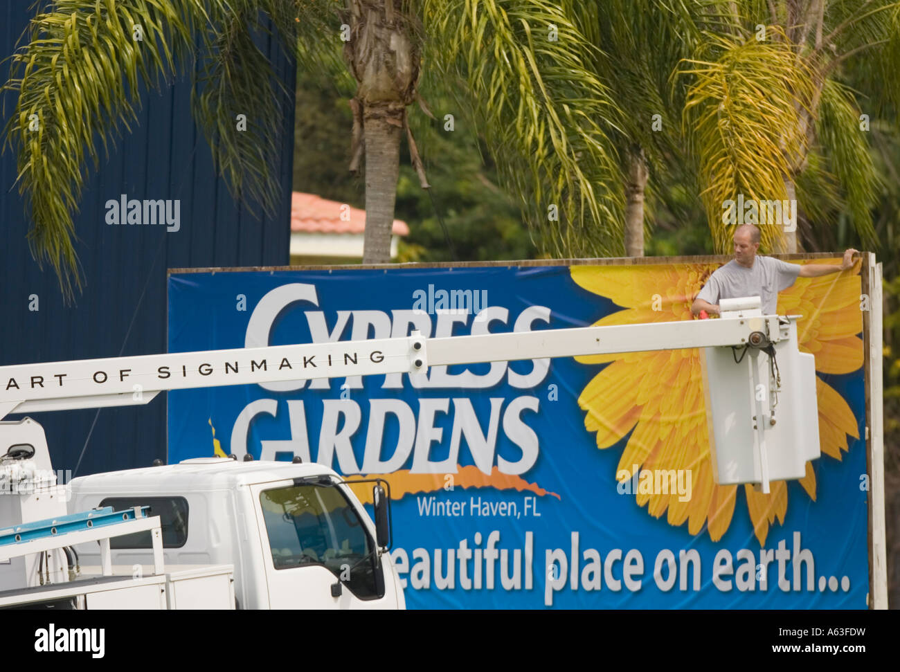 Man putting up a billboard Stock Photo - Alamy