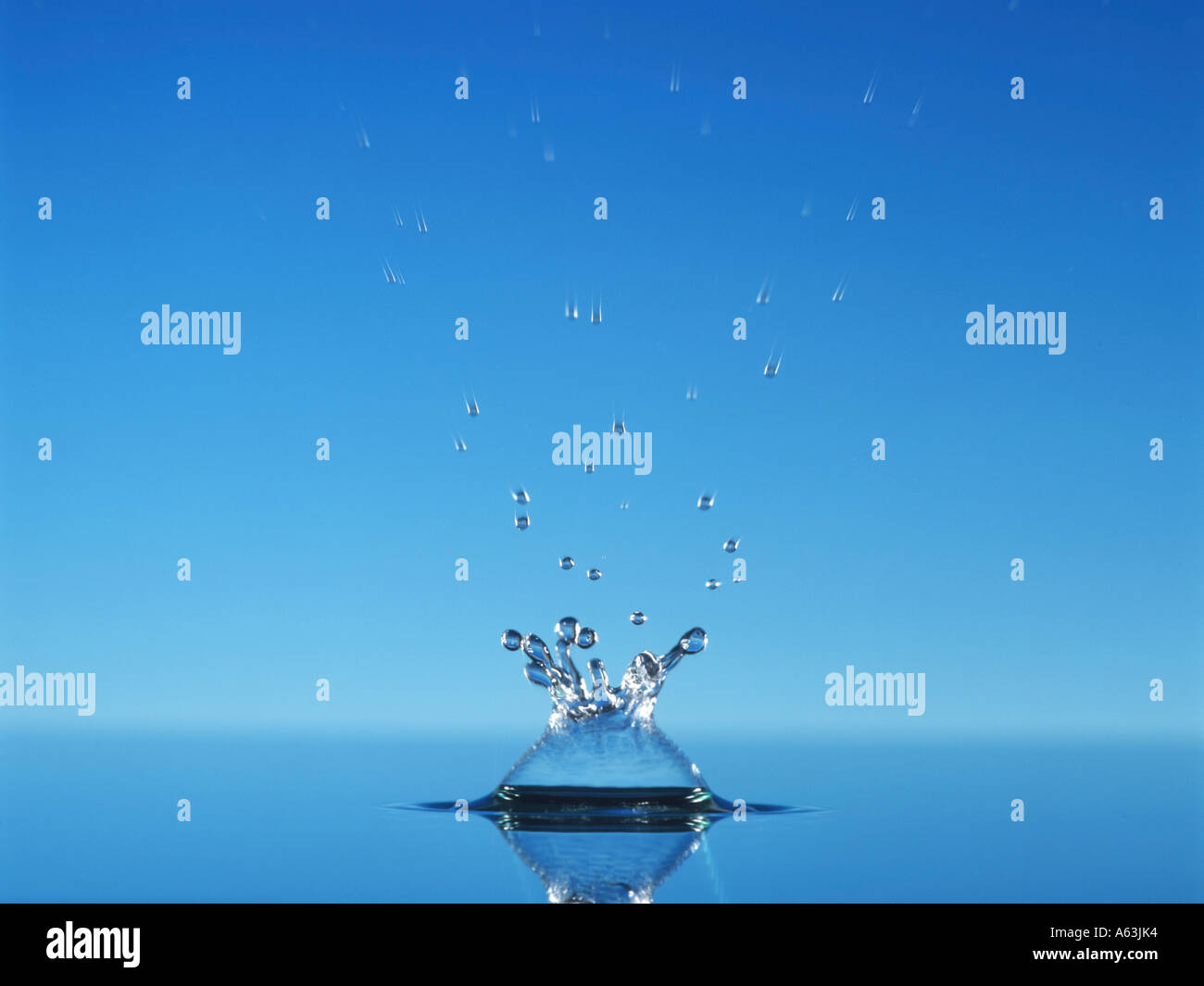 Close-up of water drop splashing on water surface Stock Photo - Alamy