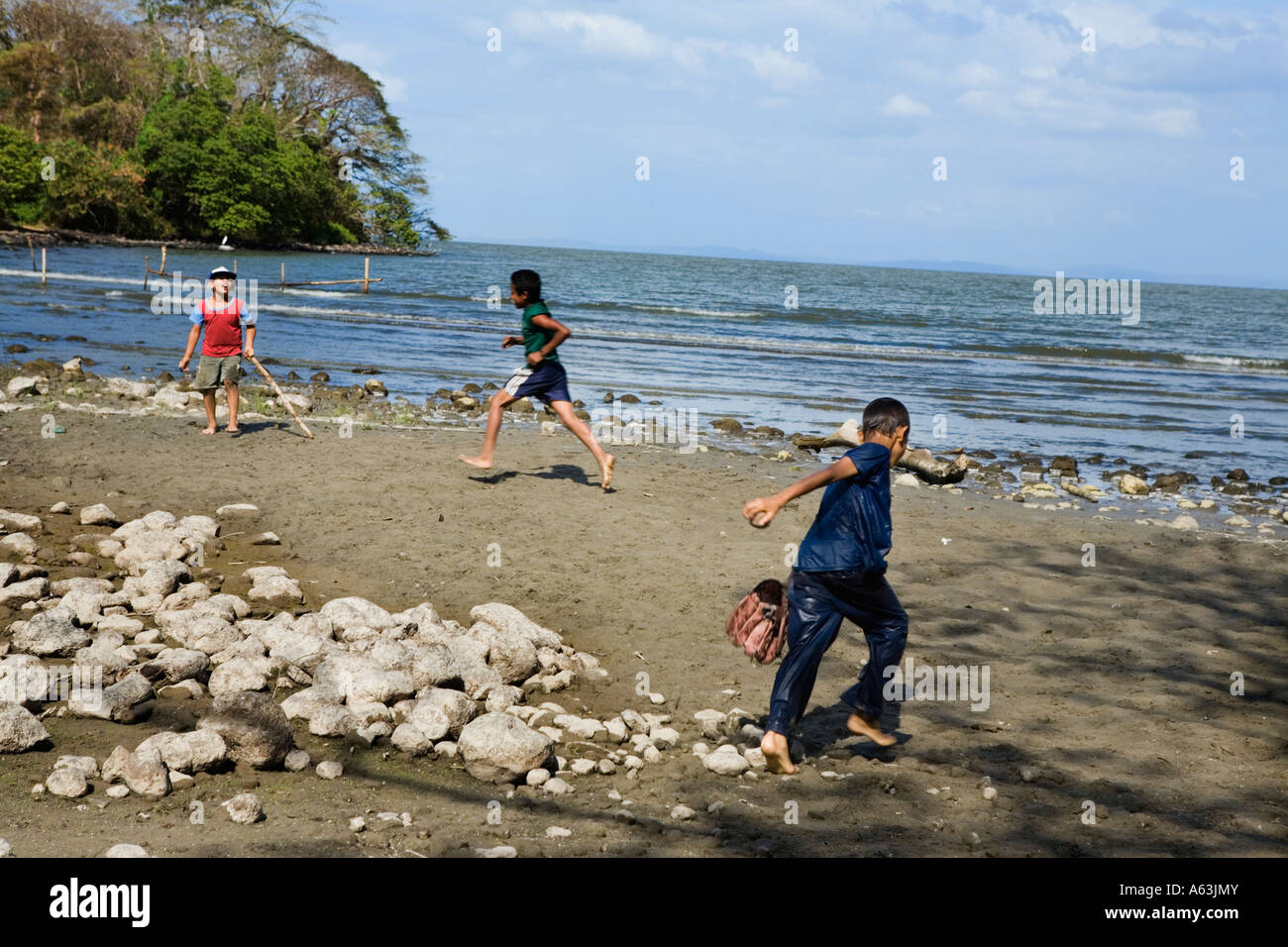Boys playing baseball barefoot on beach San Fernando aka Isla Elvis ...