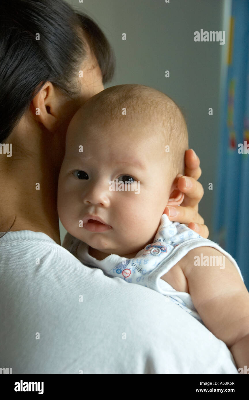 Three month old baby boy looking over mother's shoulder Stock Photo - Alamy