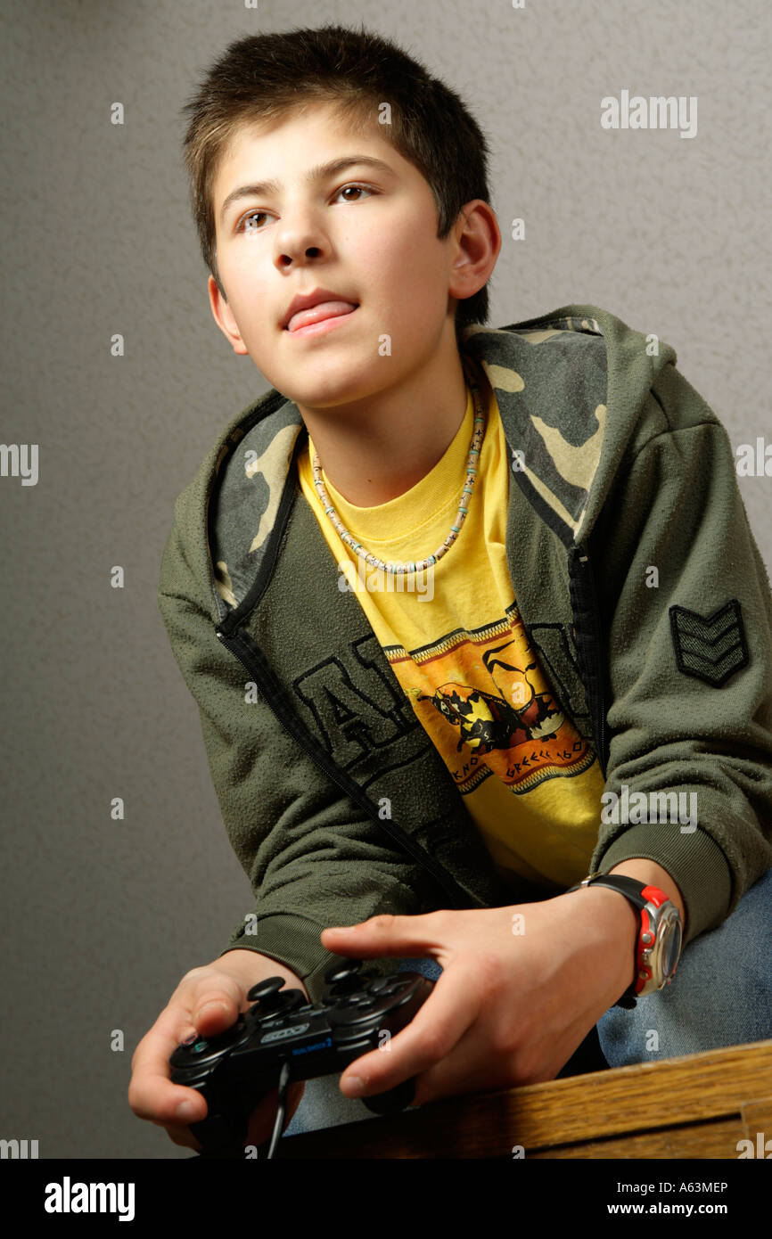 portrait of a young boy playing playstation Stock Photo - Alamy