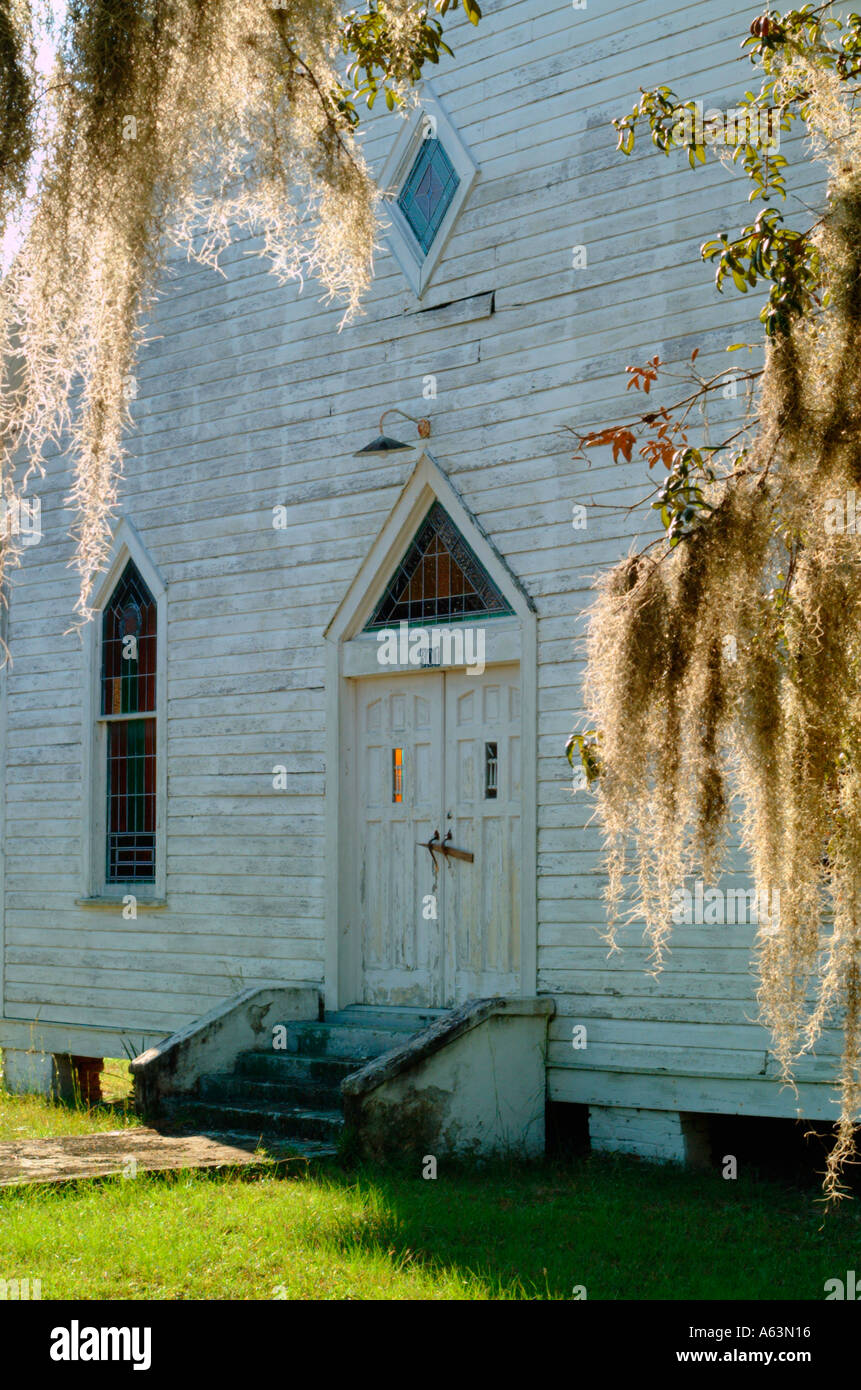 front of an old church entrance doors windows stained glass old worn ...
