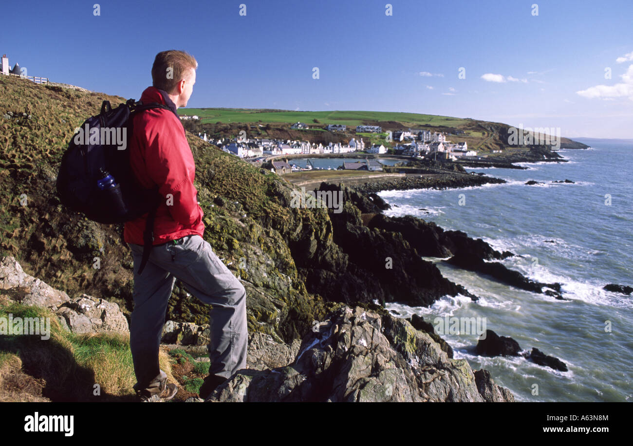 Walker on cliffs looking down on Portpatrick on the Southern Upland Way ...