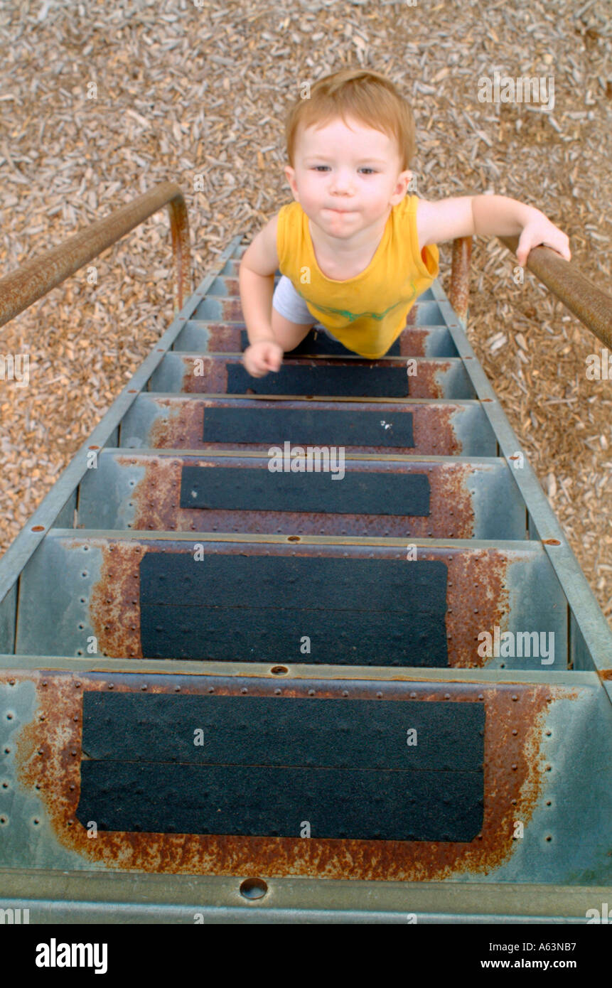 Toddler climbing stairs for slide at public park boys children parks ...