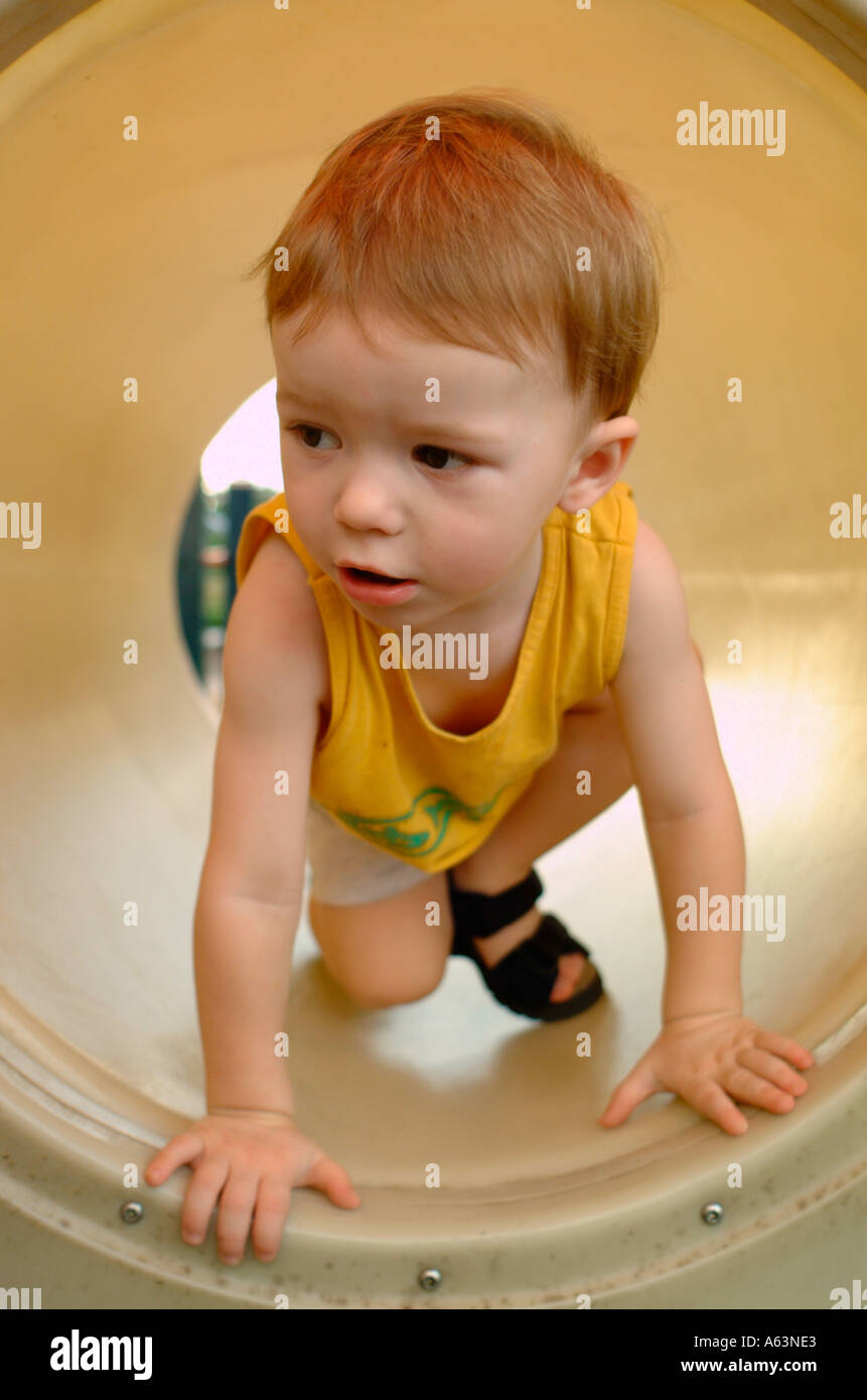 Toddler in playscape tube at public park boys children parks rides ...