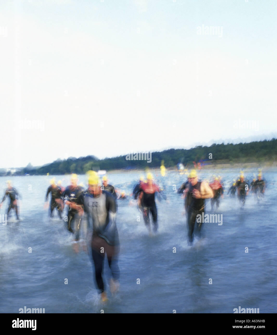 Swimmers running on beach Stock Photo - Alamy