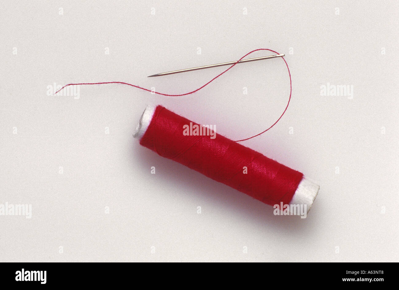 Close-up of needle and spool of thread Stock Photo - Alamy