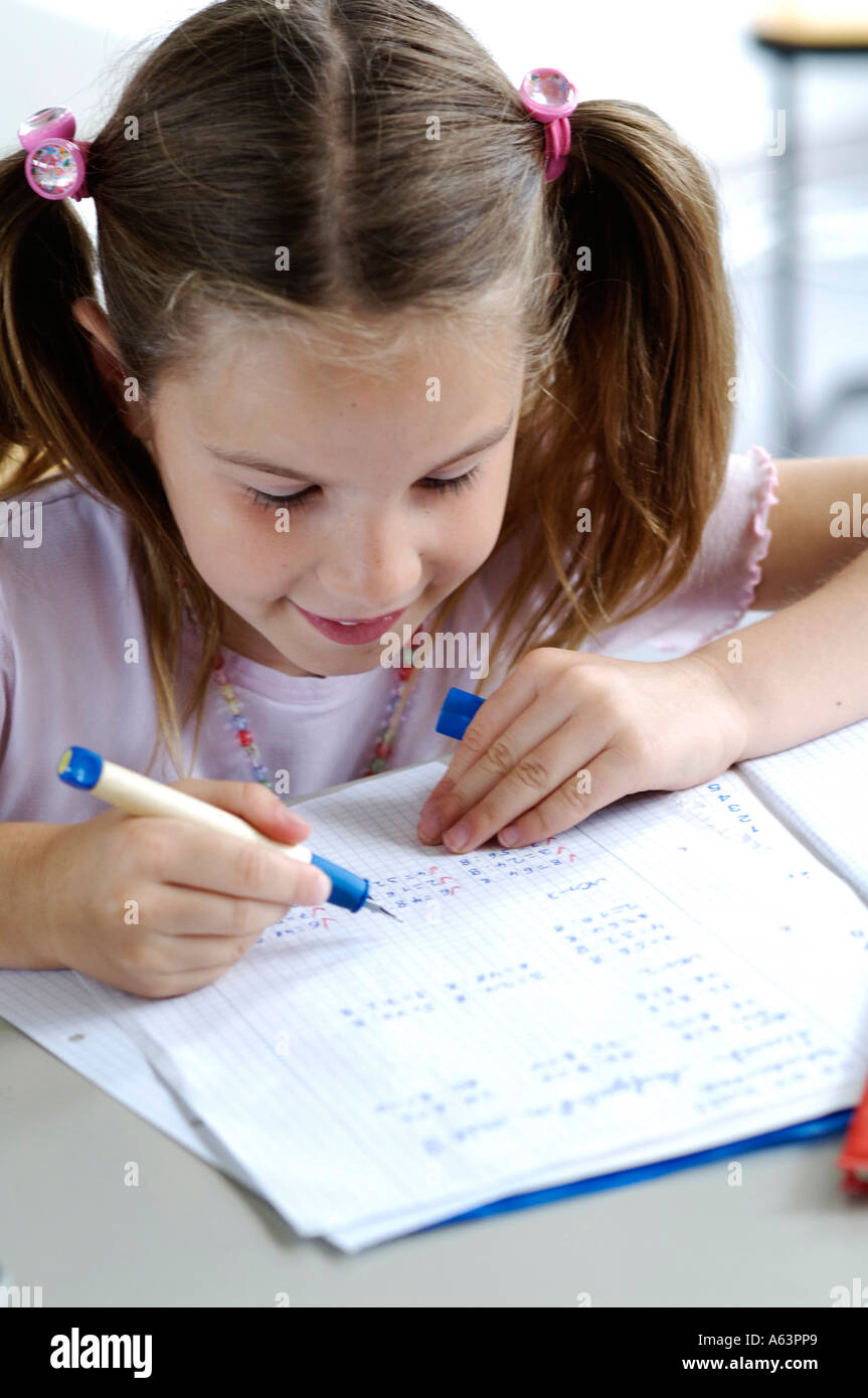 Schoolgirl writing in exercise hi-res stock photography and images - Alamy