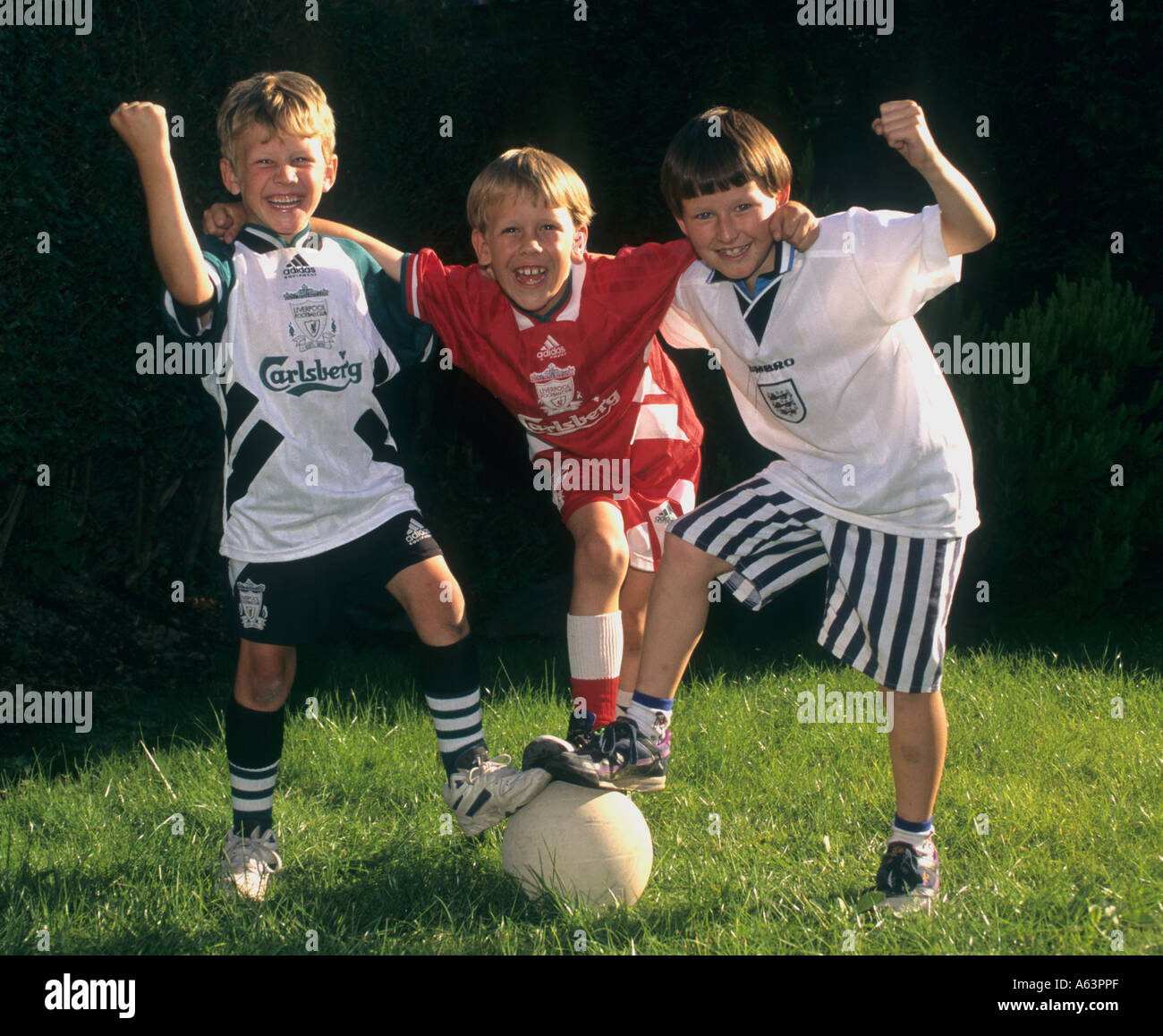 3 Young Footballers Stock Photo - Alamy