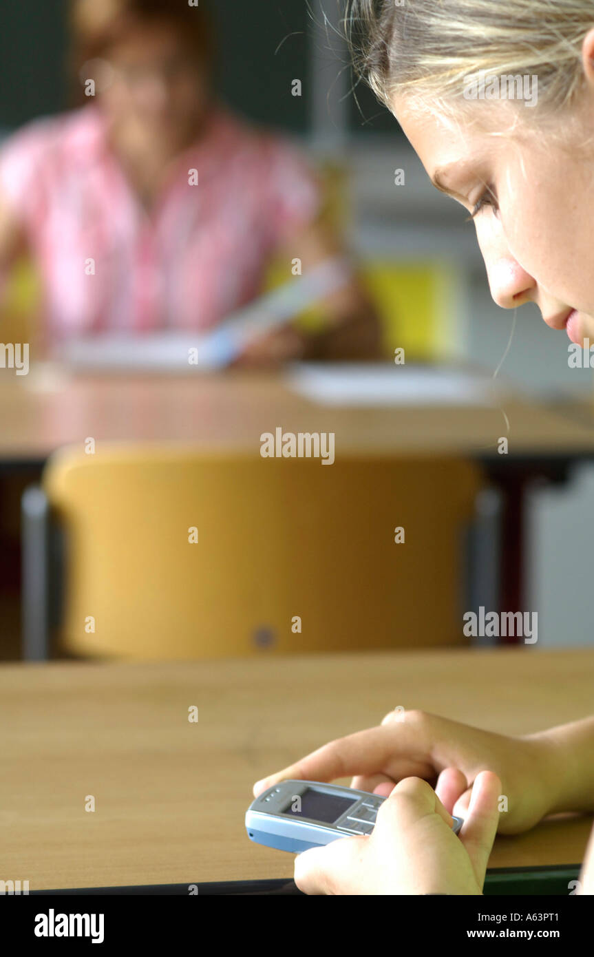 Close-up of teenage girl using mobile phone in classroom Stock Photo ...
