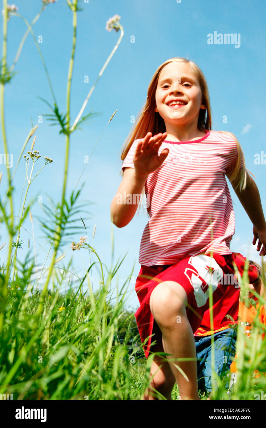 Children running over meadow Stock Photo - Alamy
