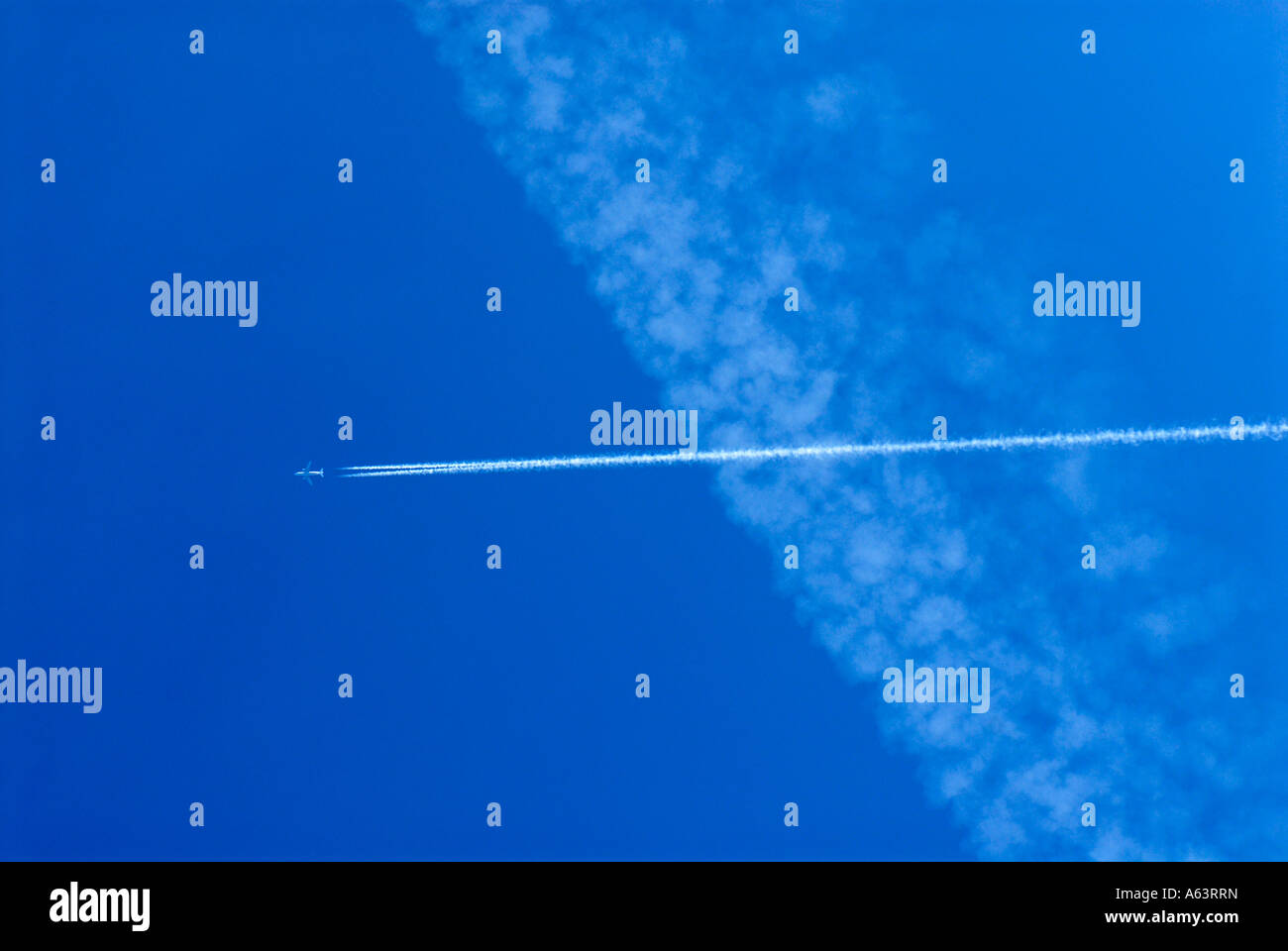Airplane with contrail Stock Photo - Alamy