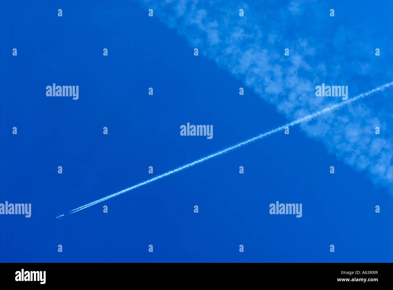 Airplane with contrail Stock Photo - Alamy