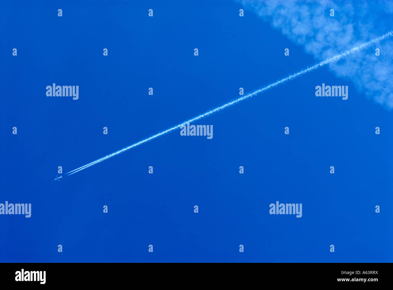 Airplane with contrail Stock Photo - Alamy