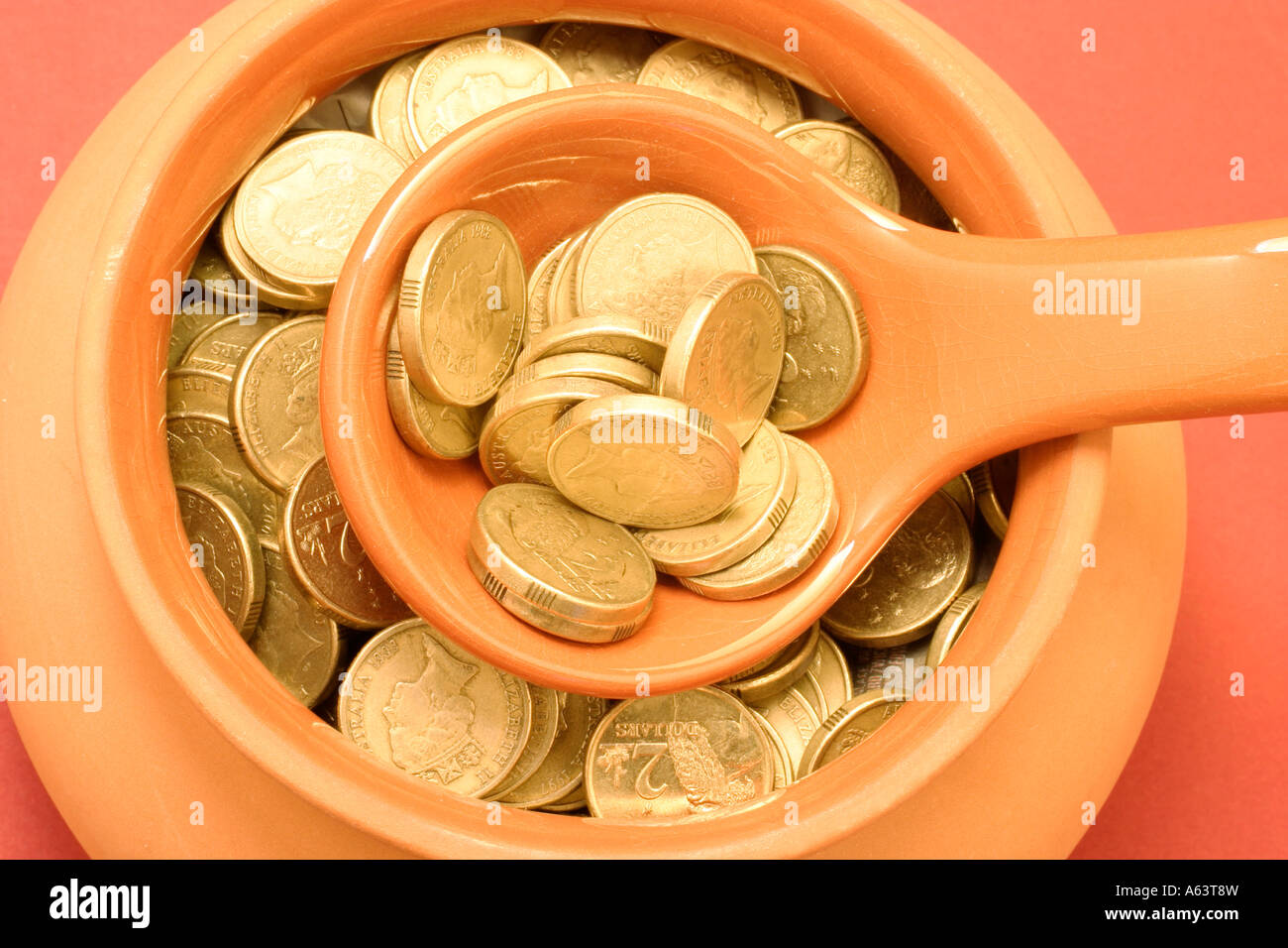 Clay Pot with Ladle and Coins Stock Photo - Alamy