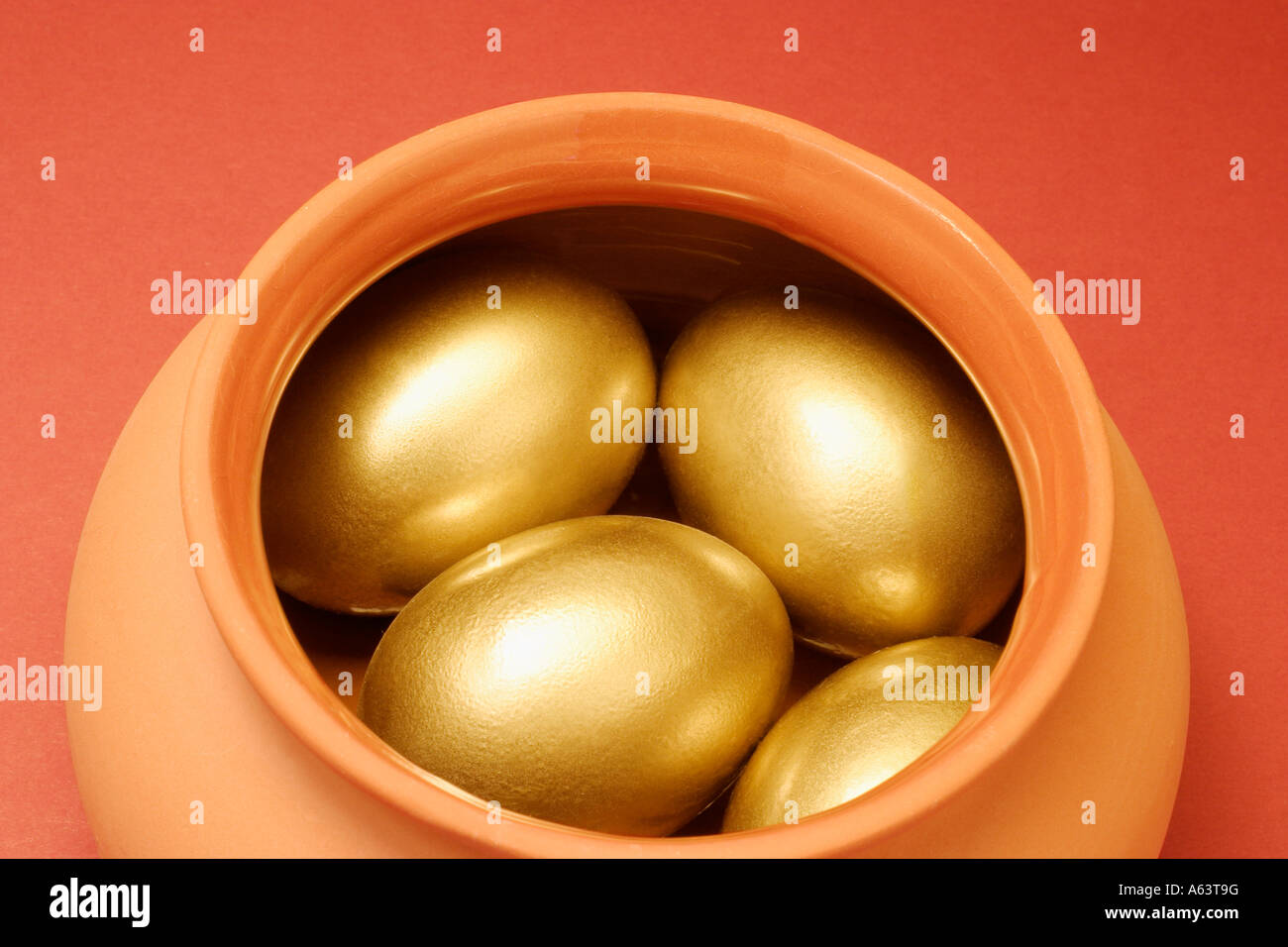 Clay Pot with Golden Eggs Stock Photo - Alamy