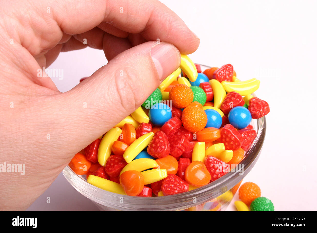 Hand taking sweets in sugar hi-res stock photography and images - Alamy