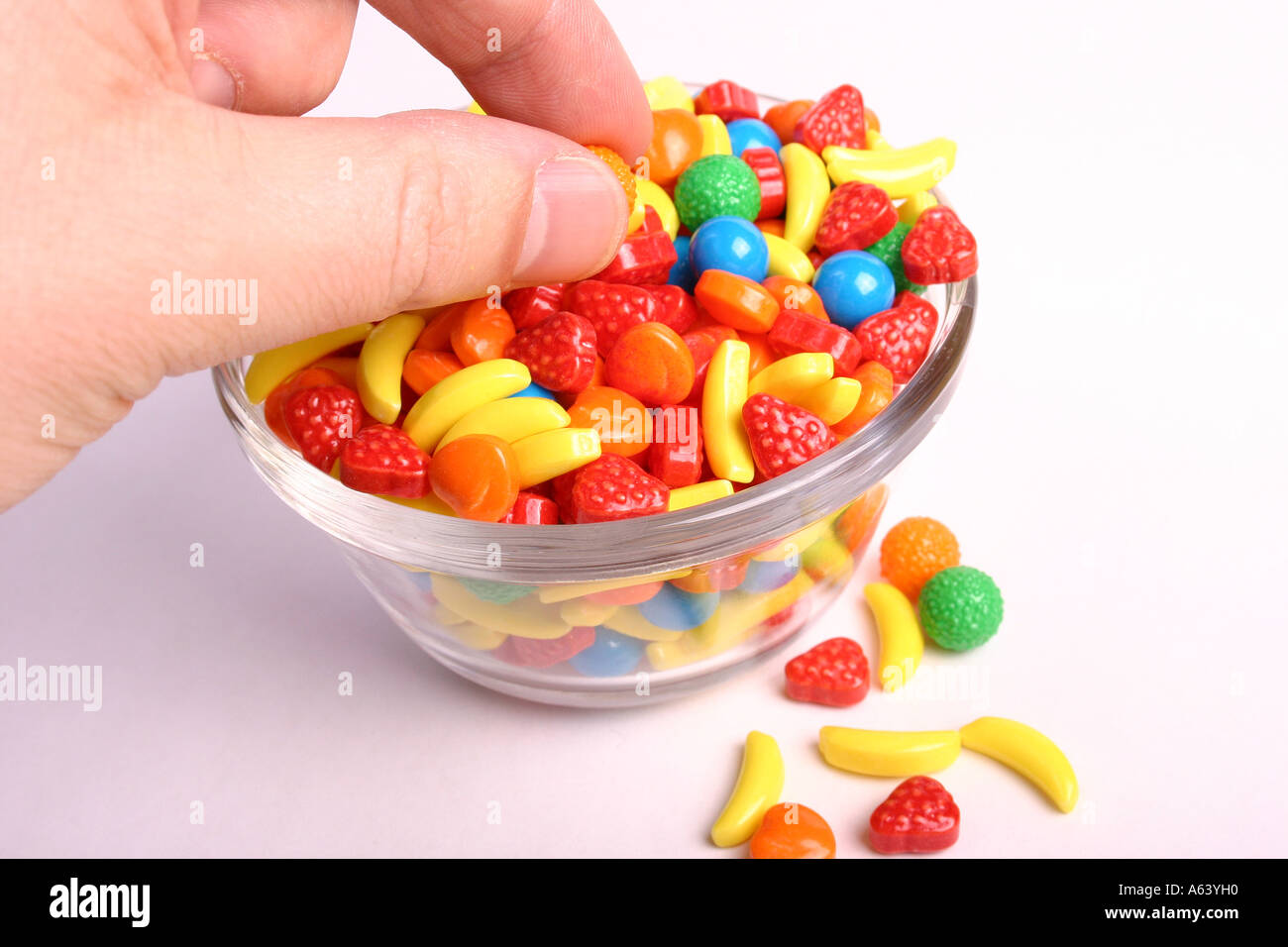 Hand taking sweets in sugar hi-res stock photography and images - Alamy