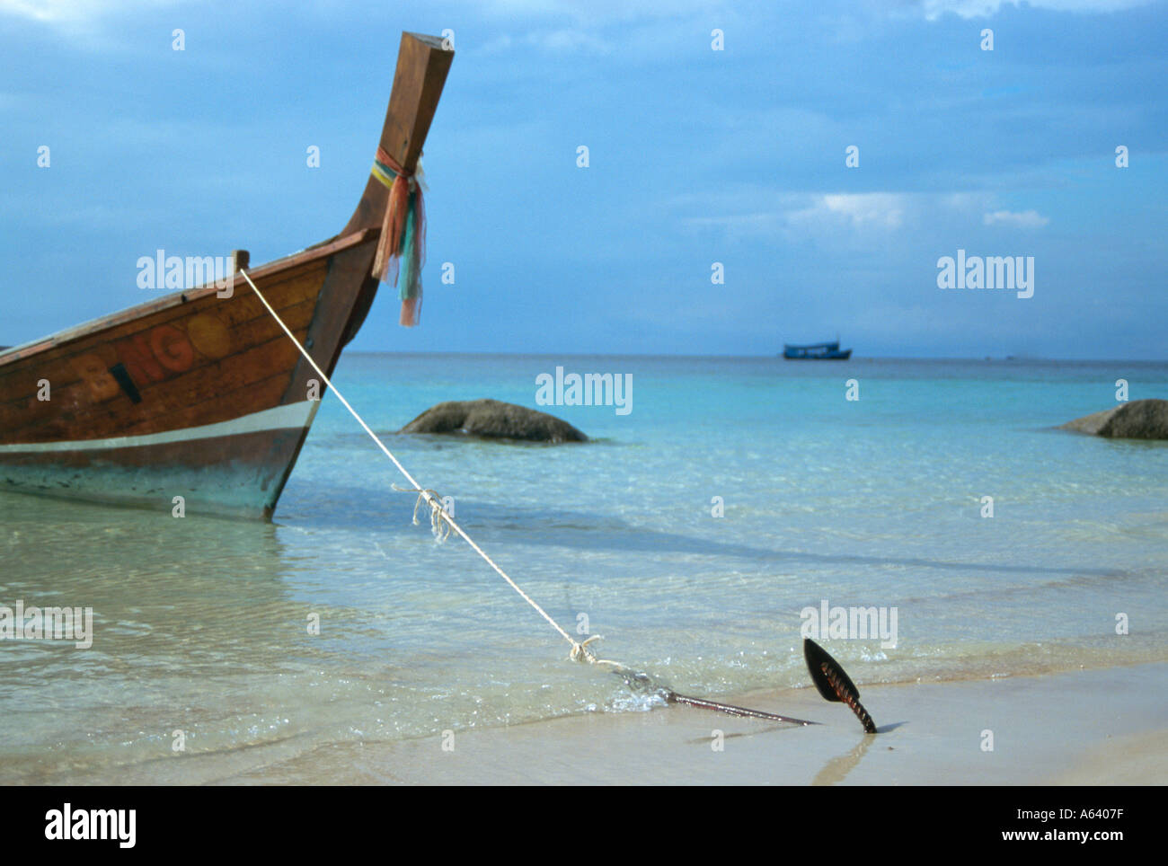 Long tail boat on a beach in Thailand Stock Photo - Alamy
