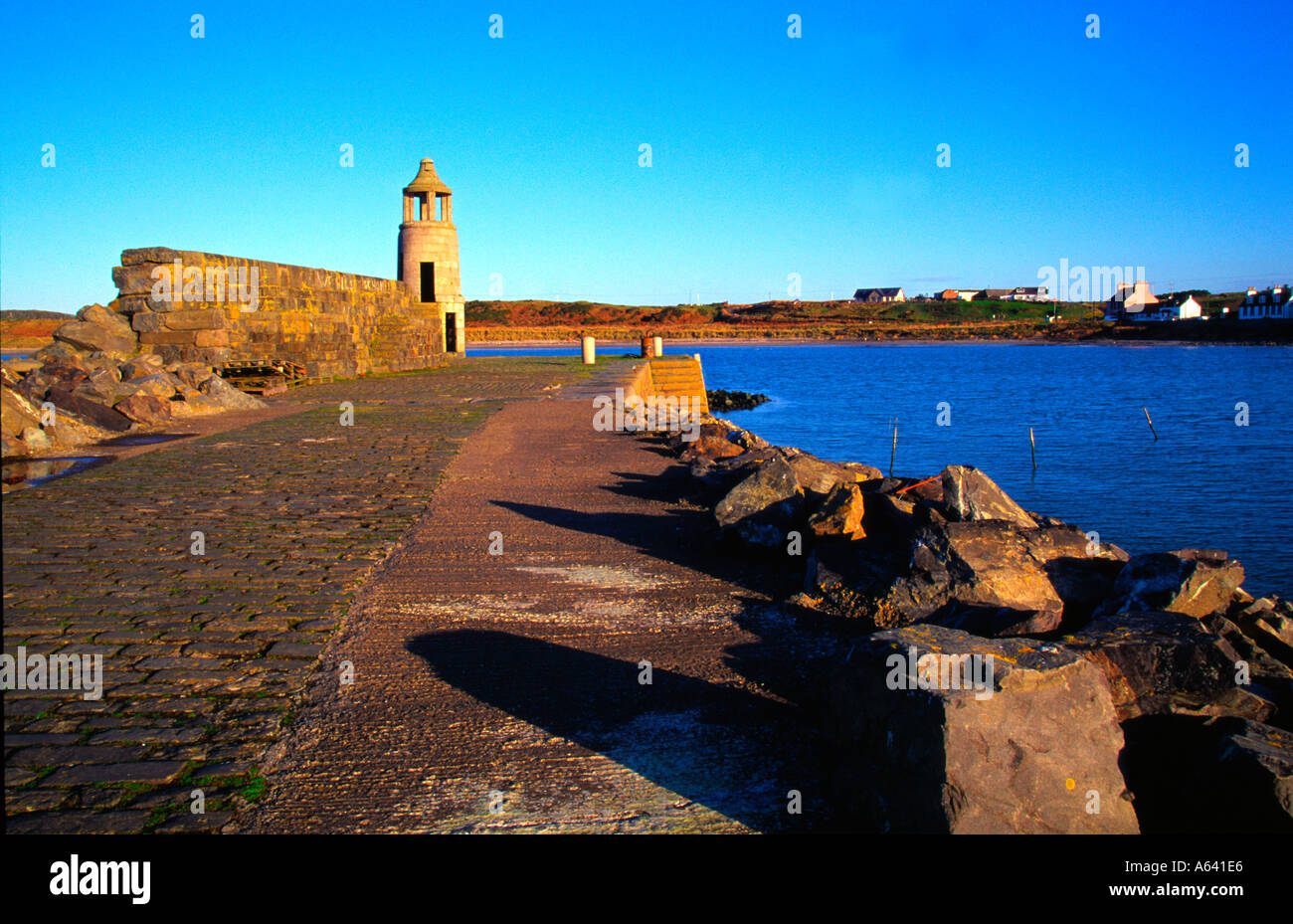 Port Logan Harbour wall and lighthouse Stock Photo - Alamy