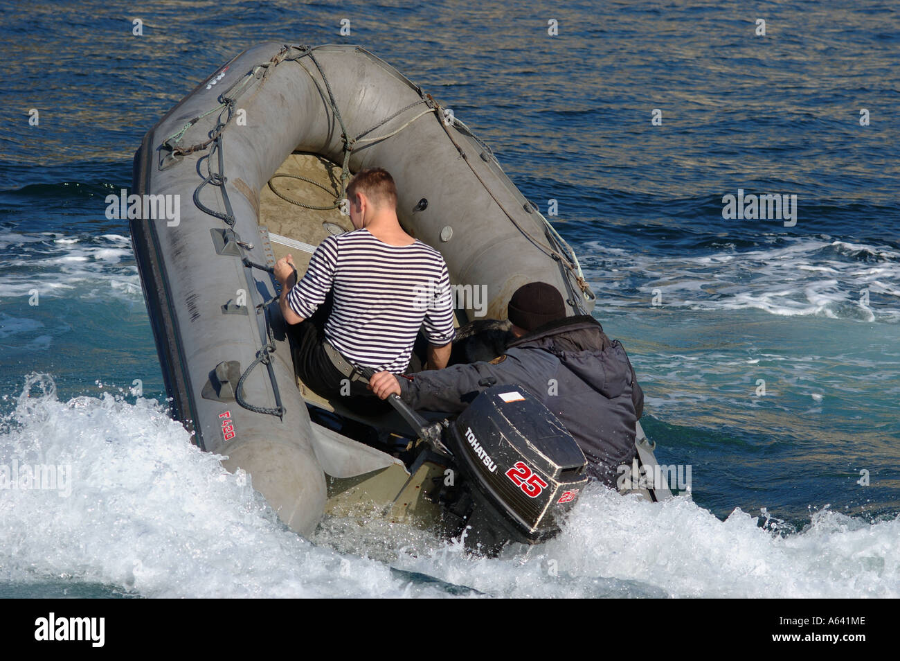 Two brave seamens hydroplaning on small rubber boat in ocean Stock ...