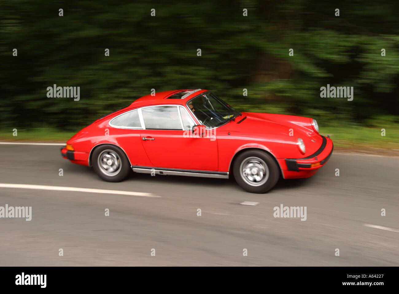 Porsche cornering at speed Stock Photo - Alamy