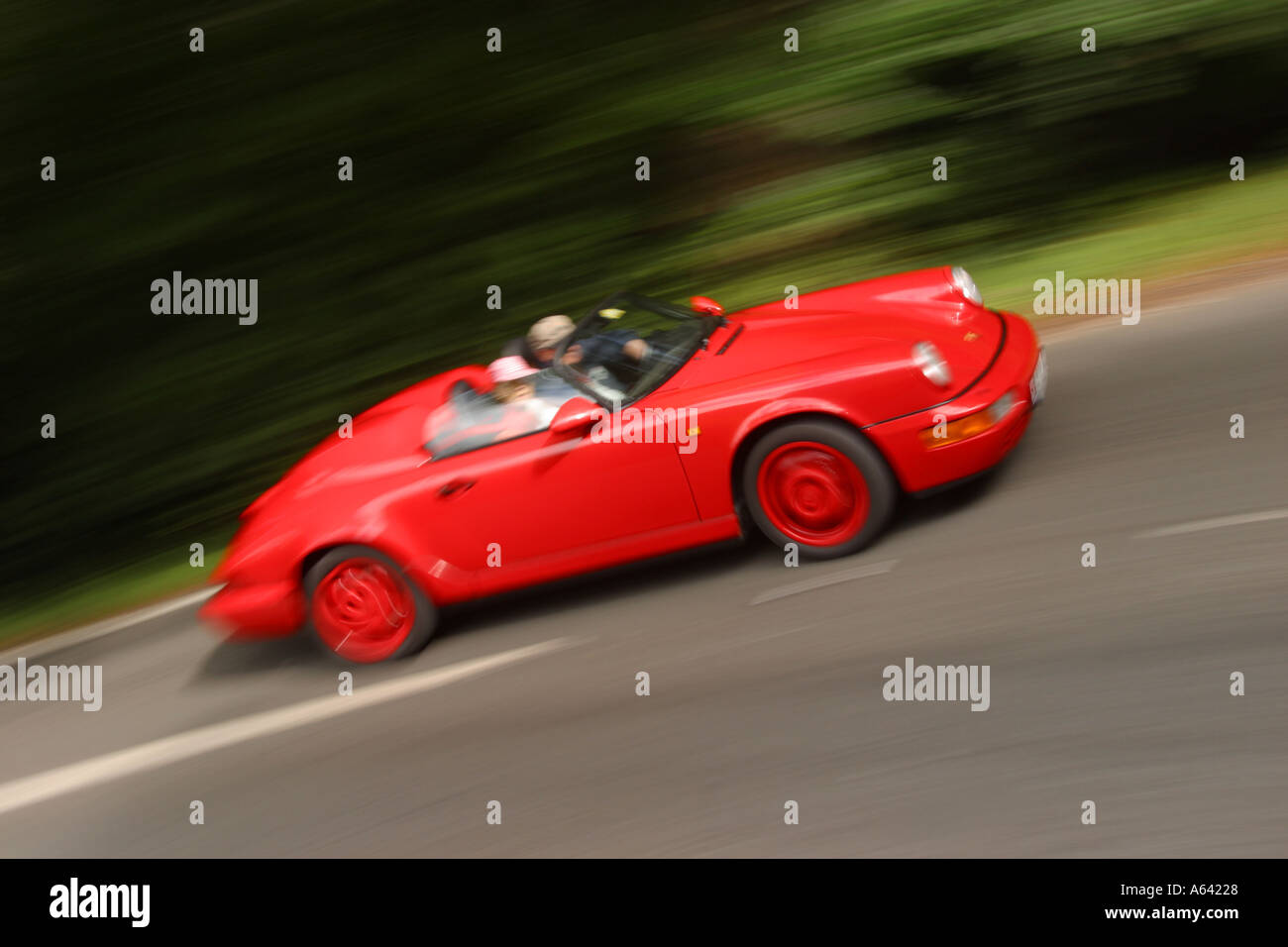 Porsche cornering at speed Stock Photo - Alamy
