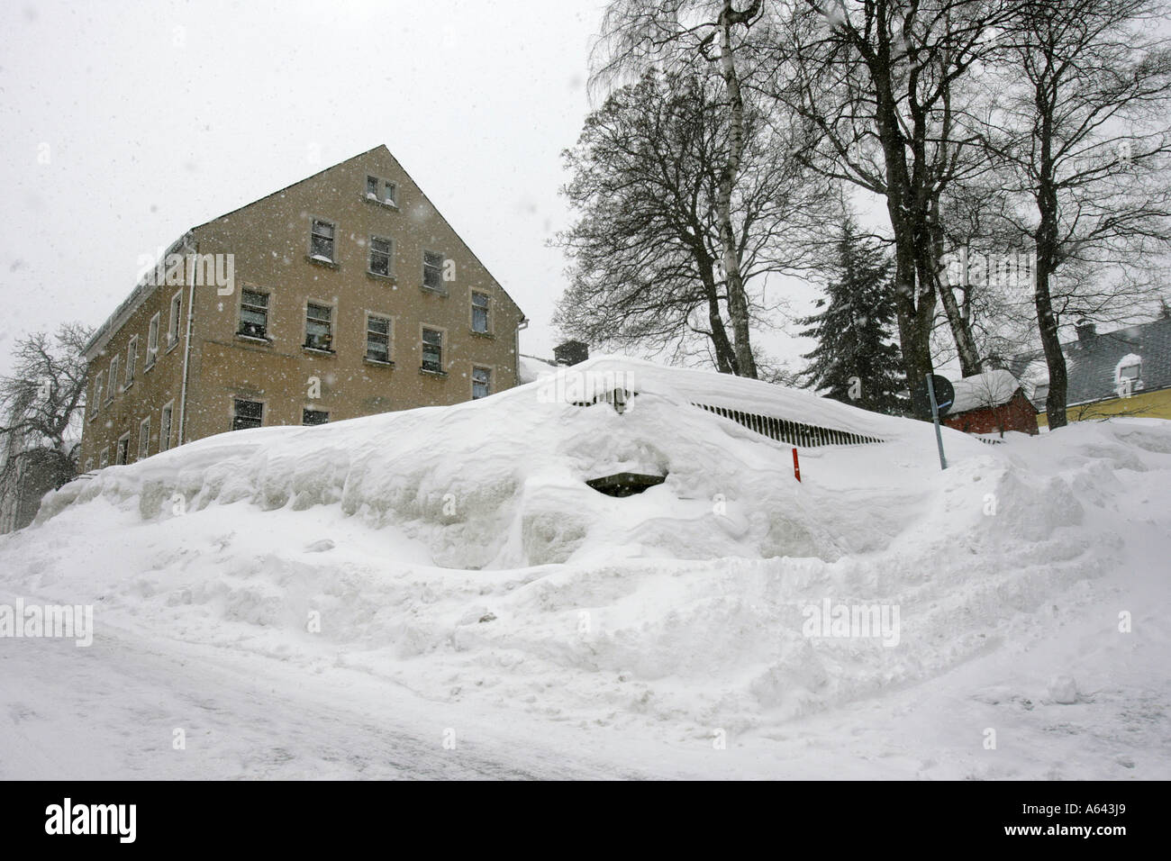 Metres high snow coveres the garden in front of an apartment house in ...