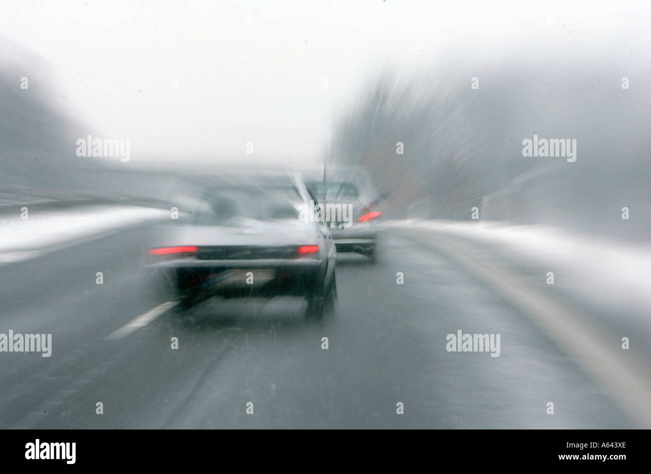 Cars driving very fast with poor visibility on a wet german Autobahn ...