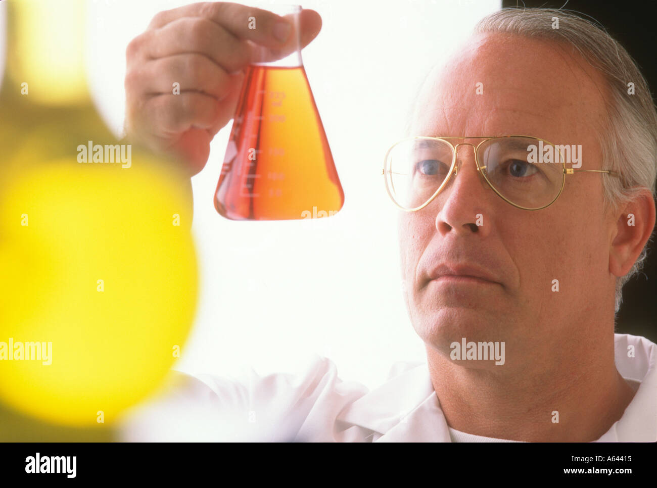 lab technician checking beakers Stock Photo - Alamy