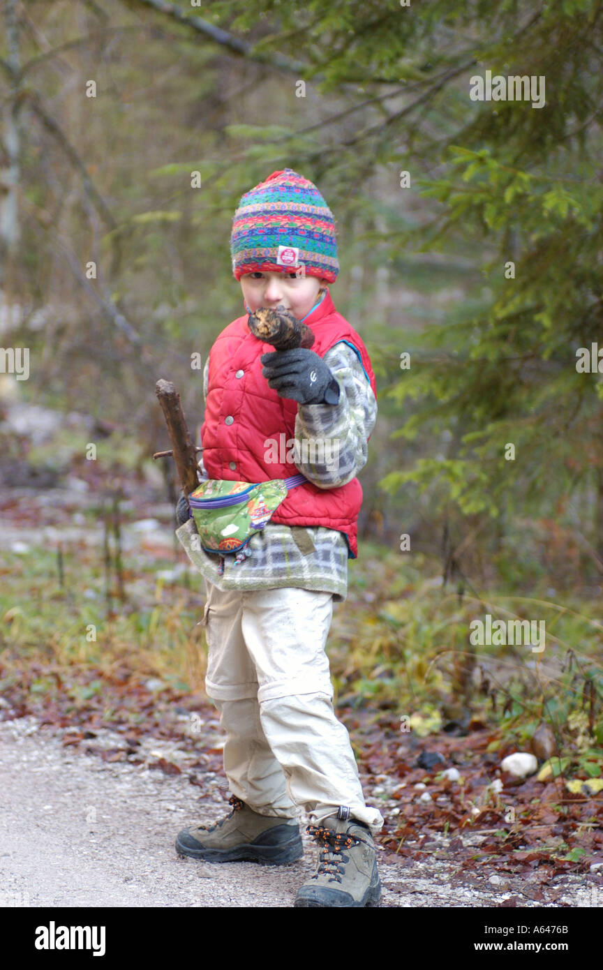 Five year old boy with wooden weapon in the forest Stock Photo - Alamy