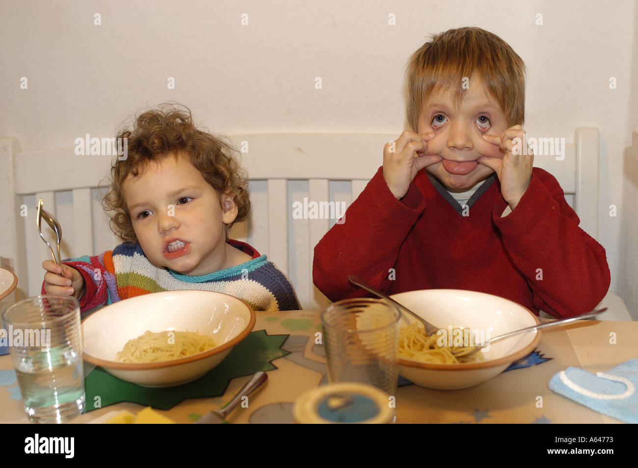 Six year old boy and three year old girl at the kitchen table boy ...