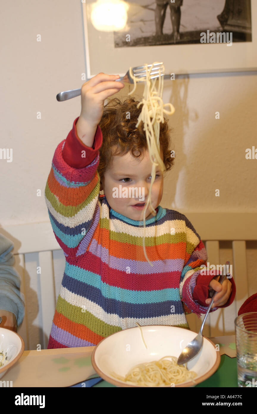Little girl eating spaghetti Stock Photo - Alamy