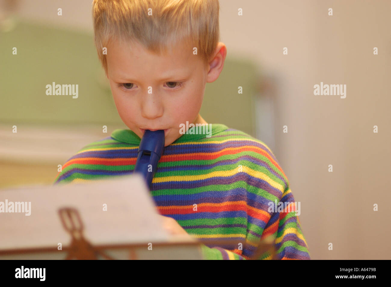 Seven year old boy playing flute Stock Photo - Alamy