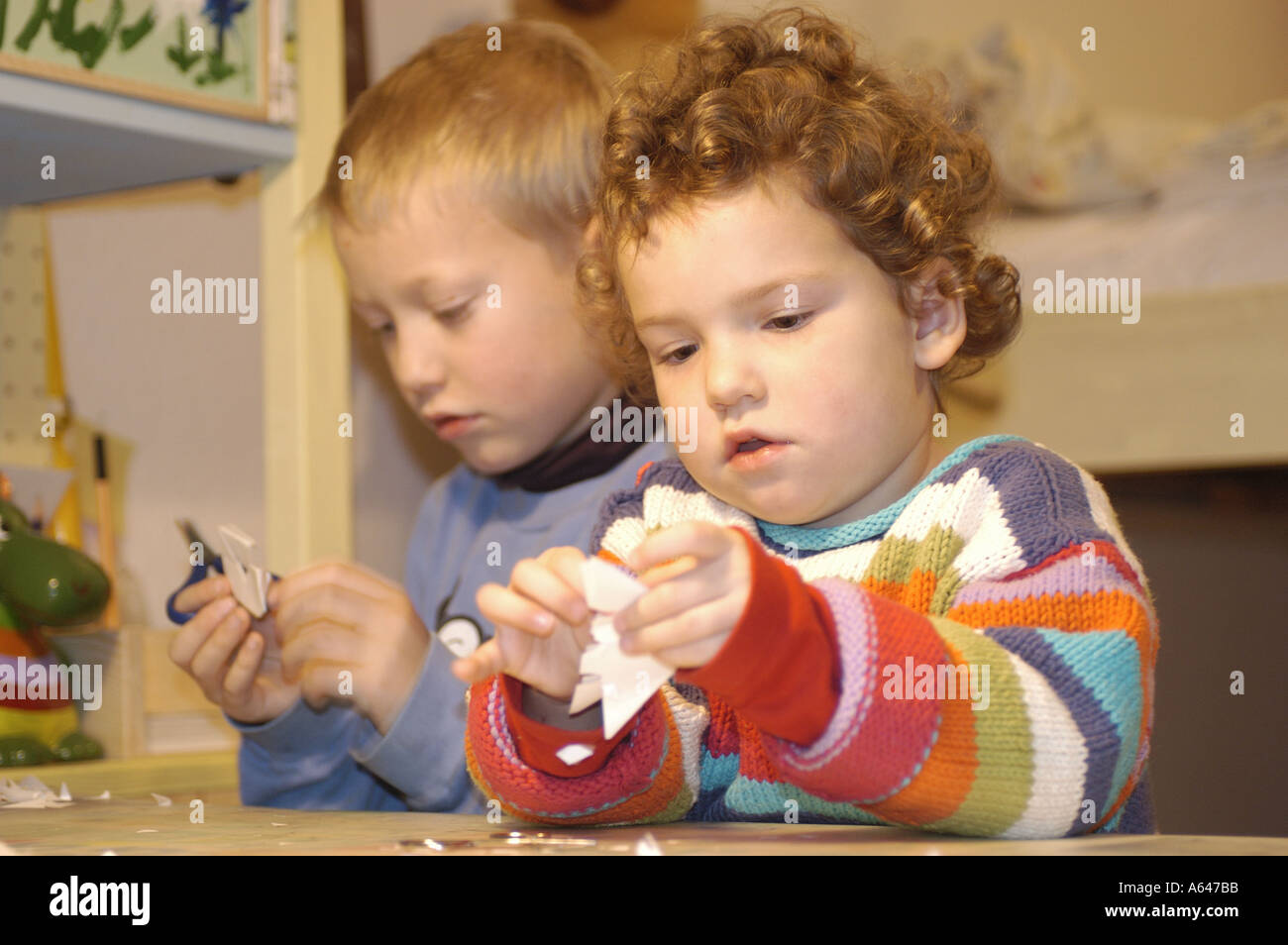 Three Year Old Girl And Seven Year Old Boy Playing Doing Handycrafts three-year-old-girl-and-seven-year-old-boy-playing-doing-handycrafts