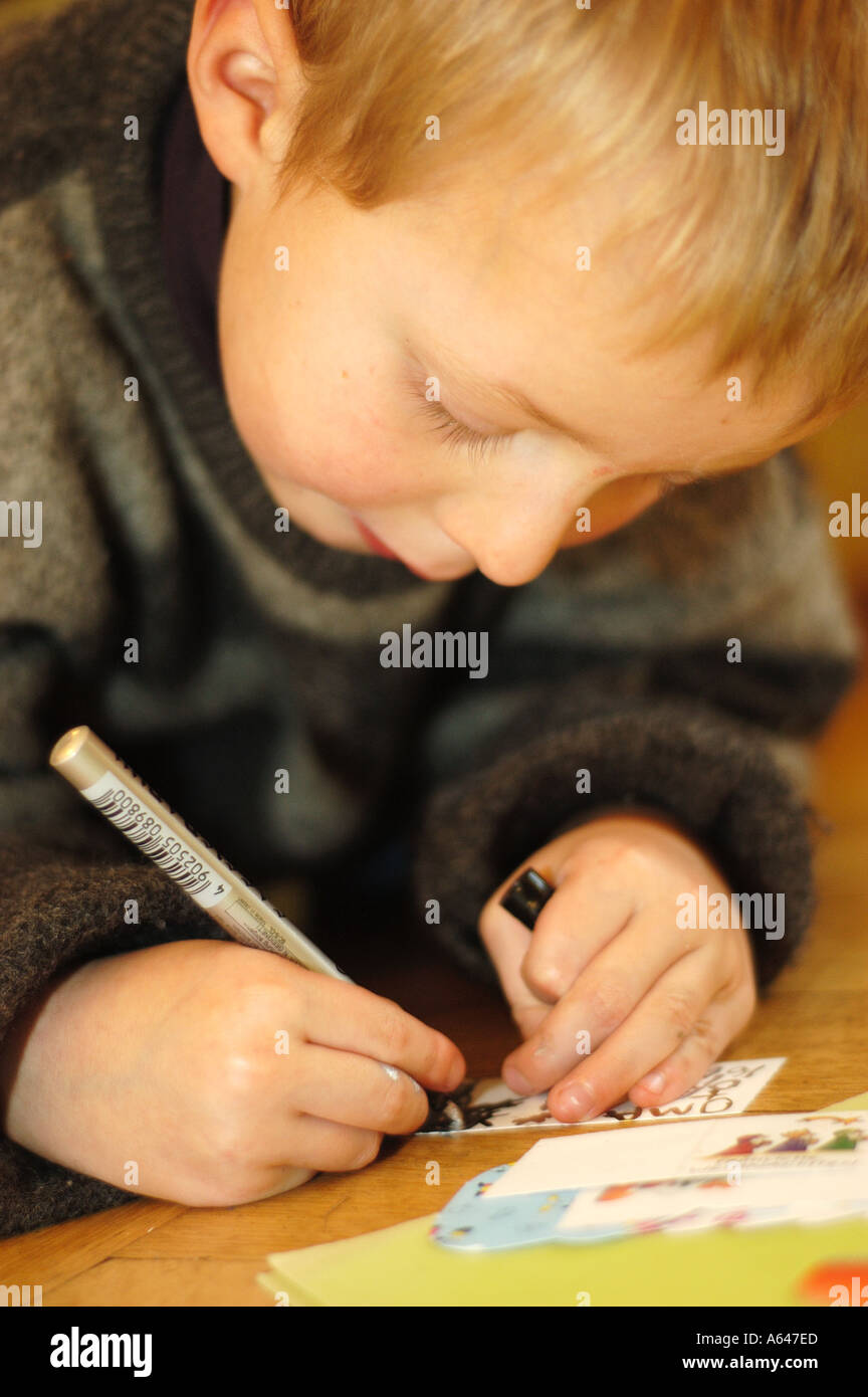 Five year old boy writing present cards for Christmas Stock Photo - Alamy