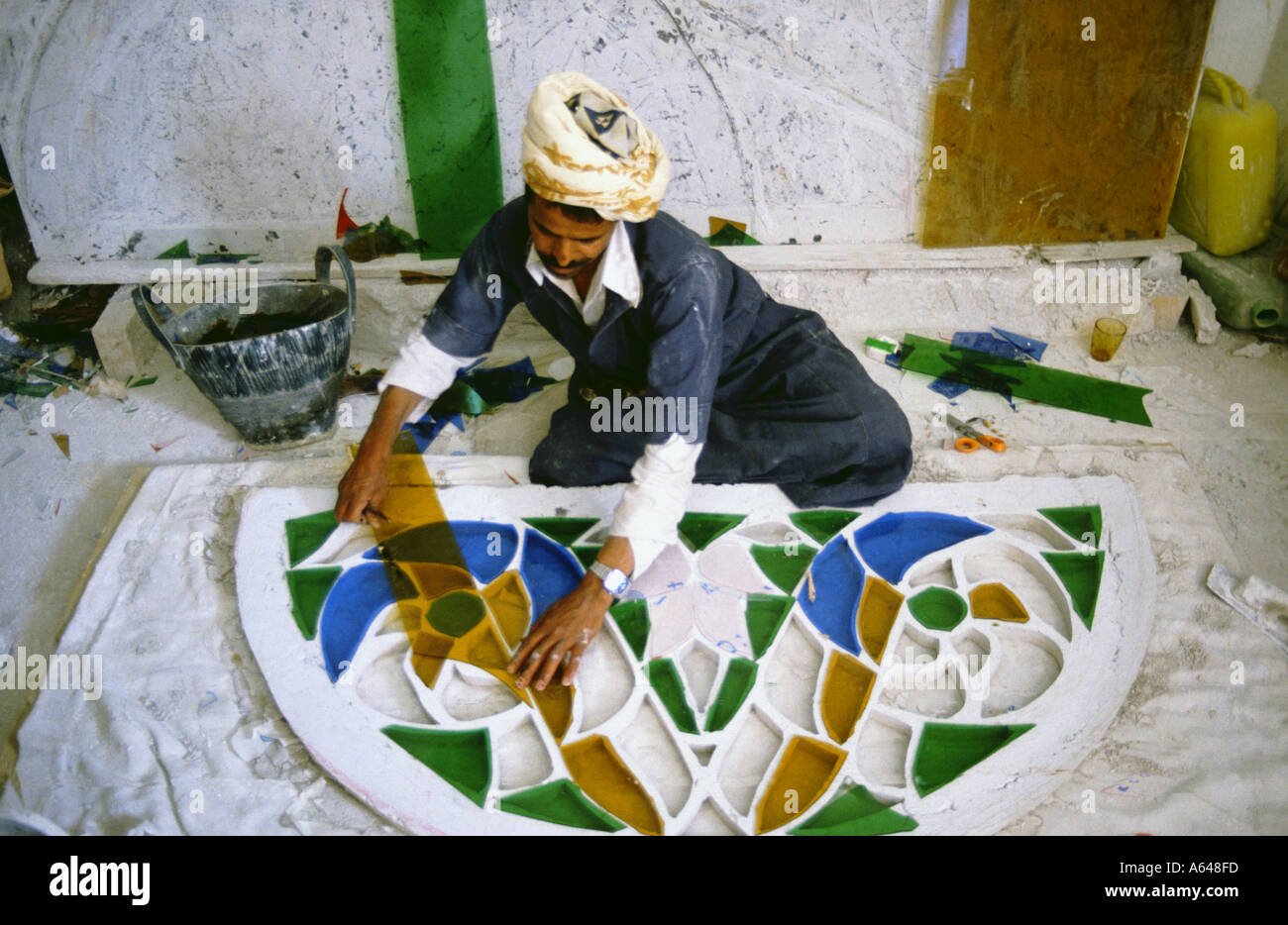 yemen jemen man at work construction of traditional colored glass ...