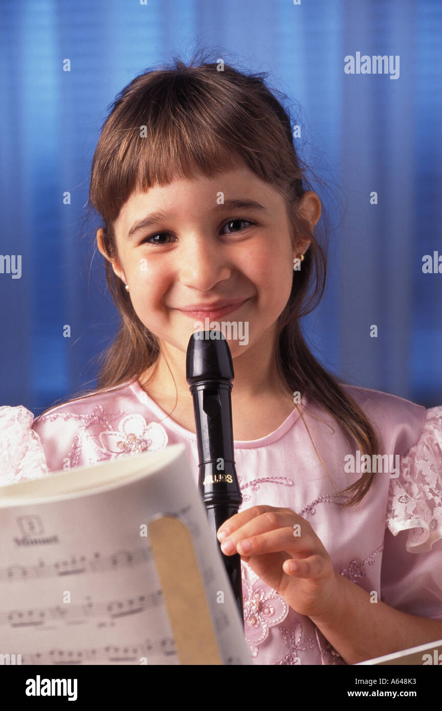 Little girl playing a recorder Stock Photo - Alamy