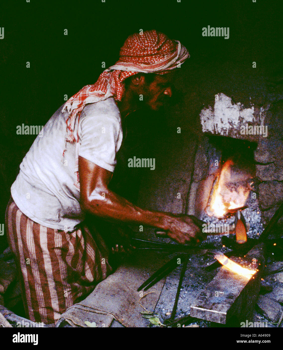yemen jemen blacksmith in a dark workshop fire forge into a knife ...