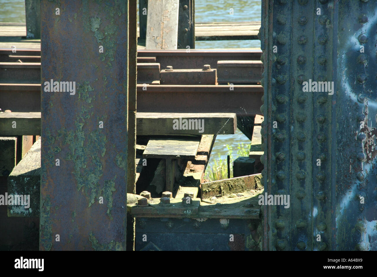 Rusty fittings at railroad trestle over water Stock Photo - Alamy