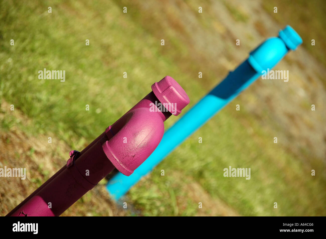 Pastel-colored stand pipes coming out of landscaping Stock Photo - Alamy