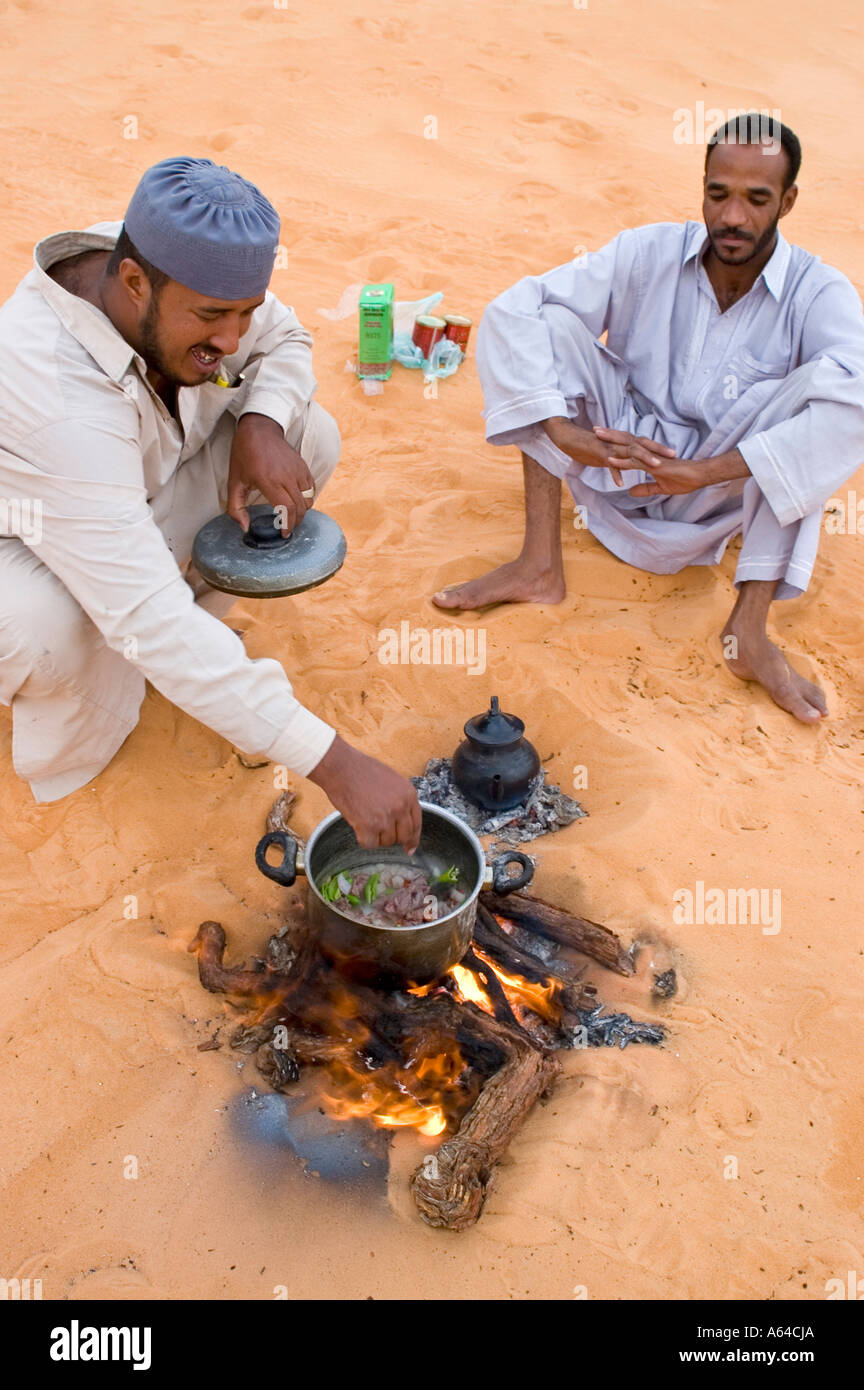 Libyan beduins sitting in the sand cooking their meal, Libya Stock ...