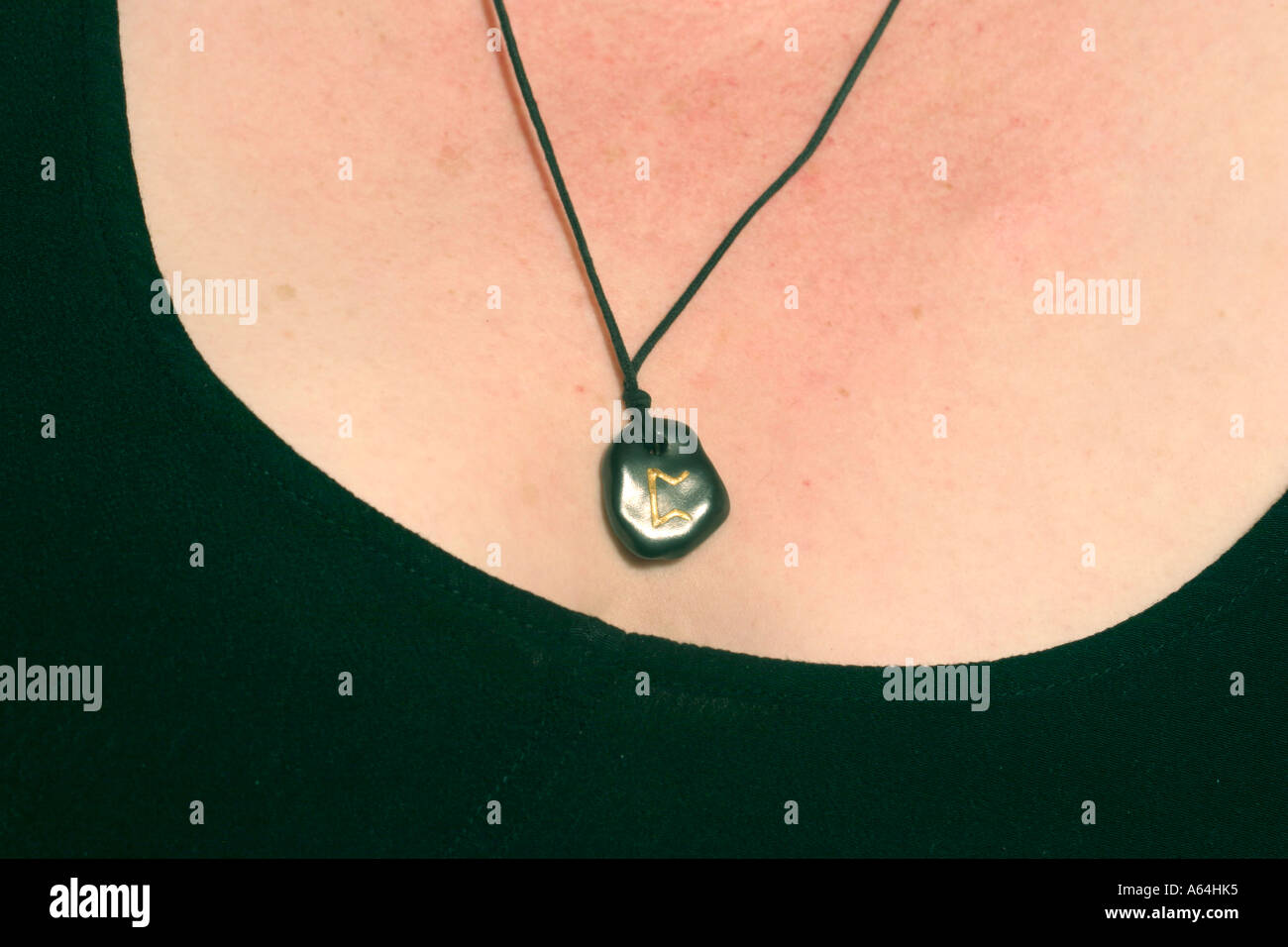 A rune pendant worn around the neck on a leather thong Stock Photo - Alamy